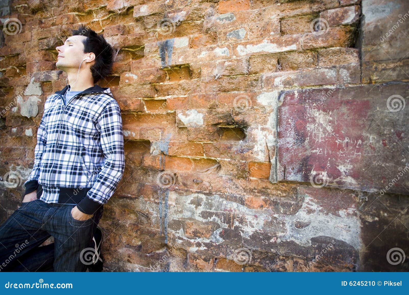 Man leaning against wall stock photo. Image of male, jeans - 6245210
