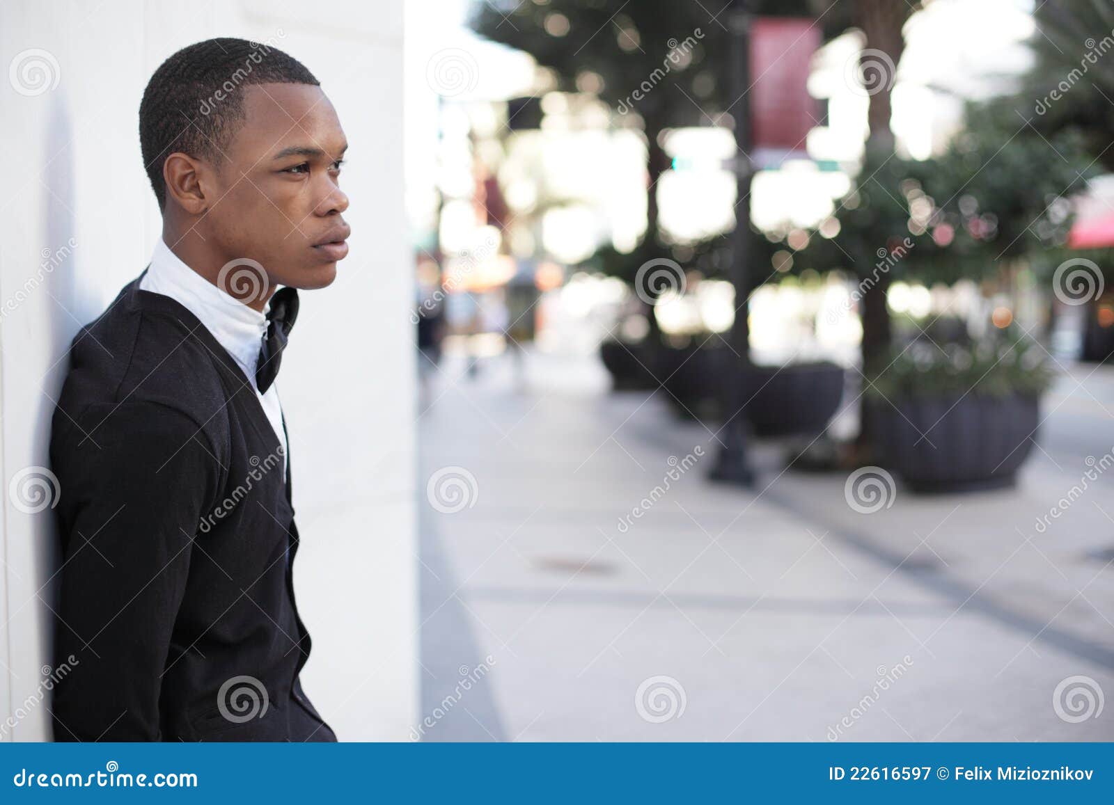 Man Leaning on a Building Wall Stock Image - Image of thin, male: 22616597