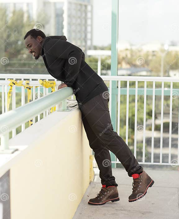 Man leaning over the ledge stock photo. Image of looking - 22304894
