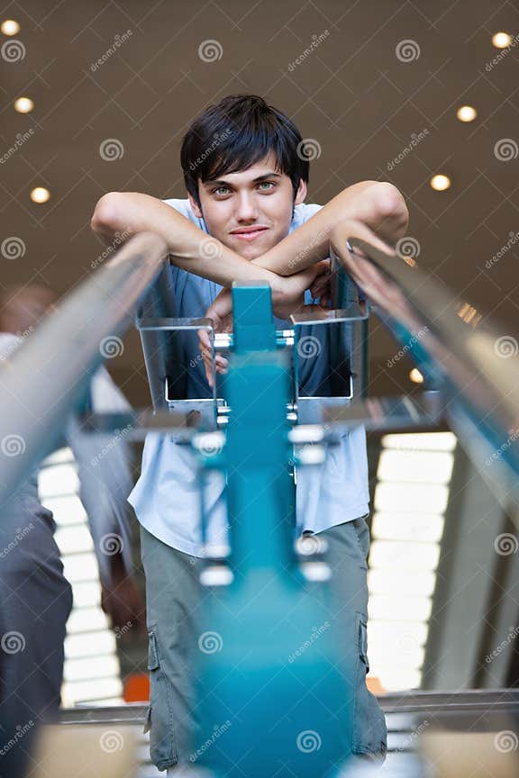 Man Leaning on Stair Railing Stock Photo - Image of relaxed, teenager ...