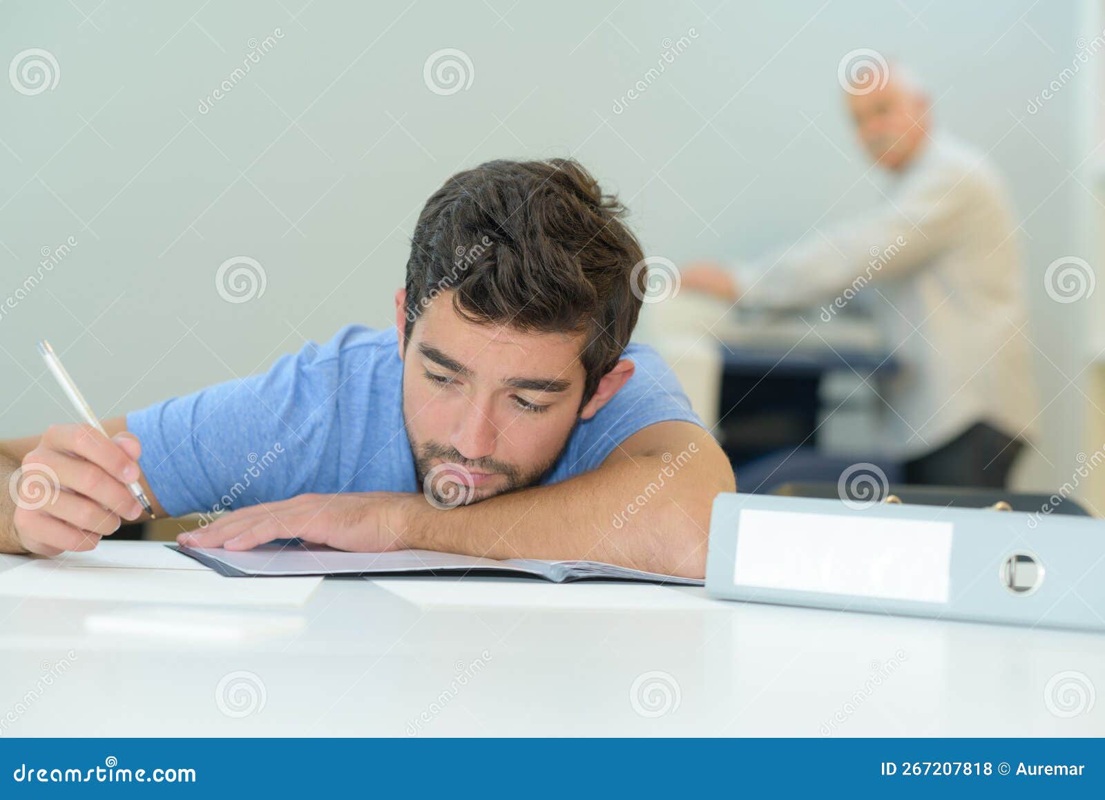 Man Leaning on Table To Fill in Paperwork Stock Photo - Image of ...