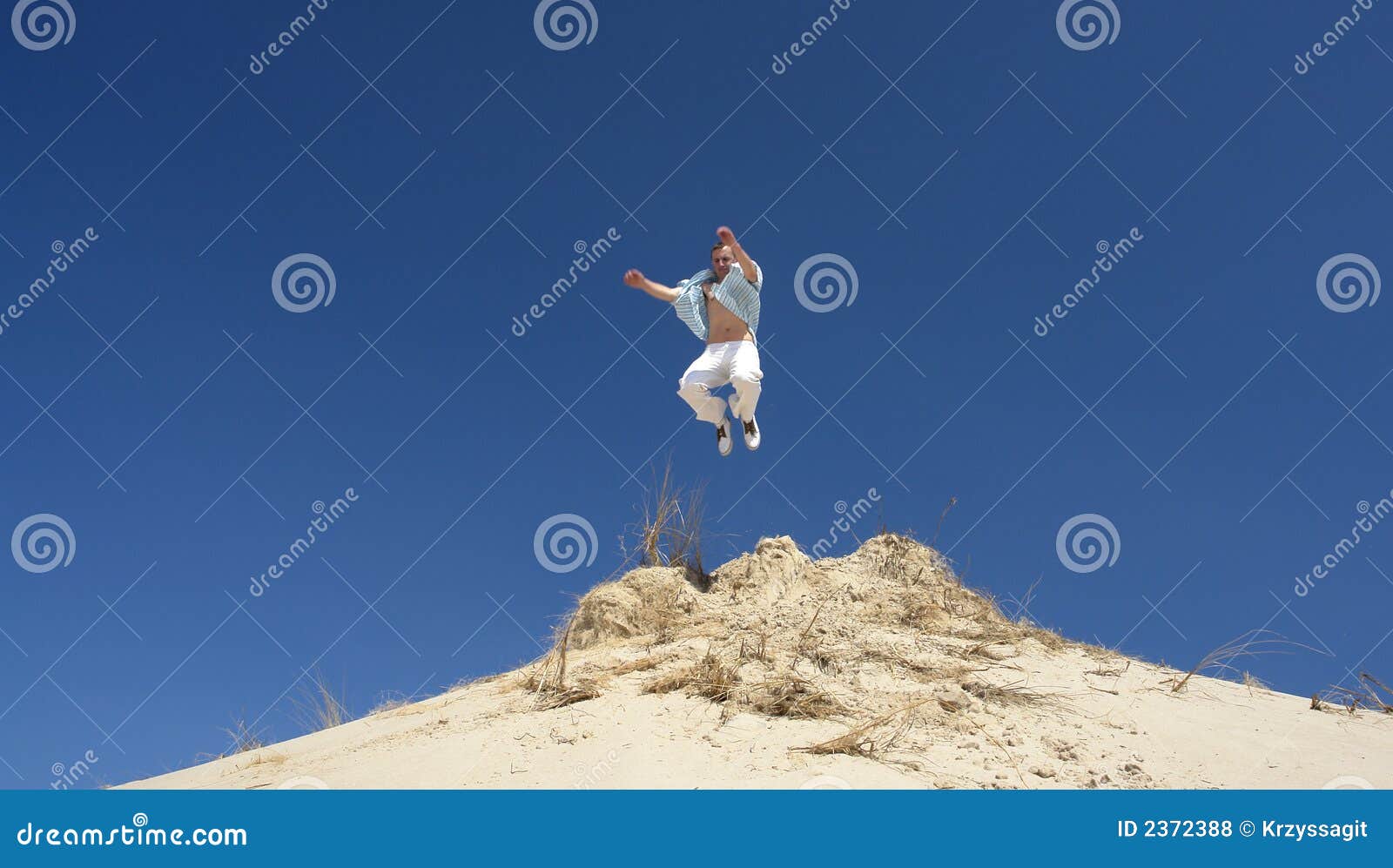 Man Leaping on Hilltop stock photo. Image of sunshine - 2372388