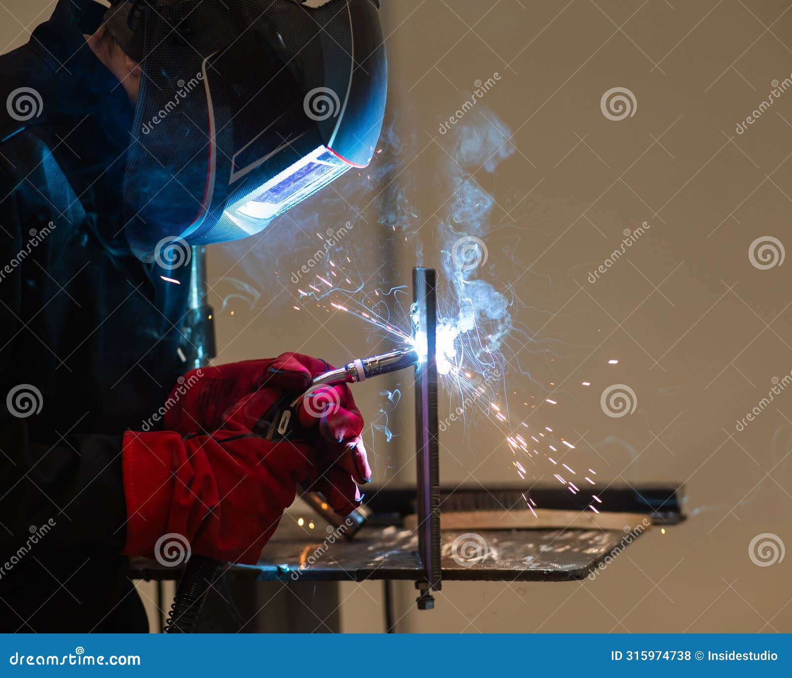 A Man Learns the Craft of Welding on a Sample. Stock Photo - Image of ...