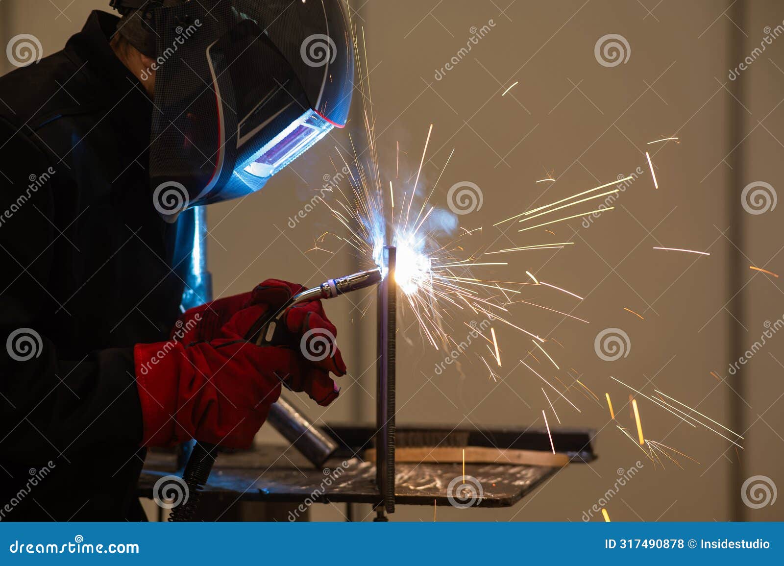 A Man Learns the Craft of Welding on a Sample. Stock Photo - Image of ...