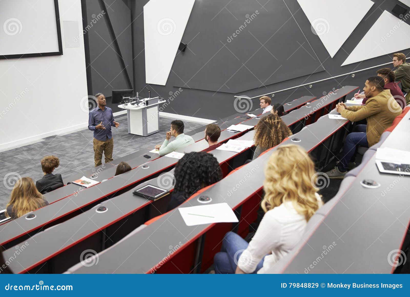 Man Lectures Students in Lecture Theatre, Mid Row Seat POV Stock Image ...