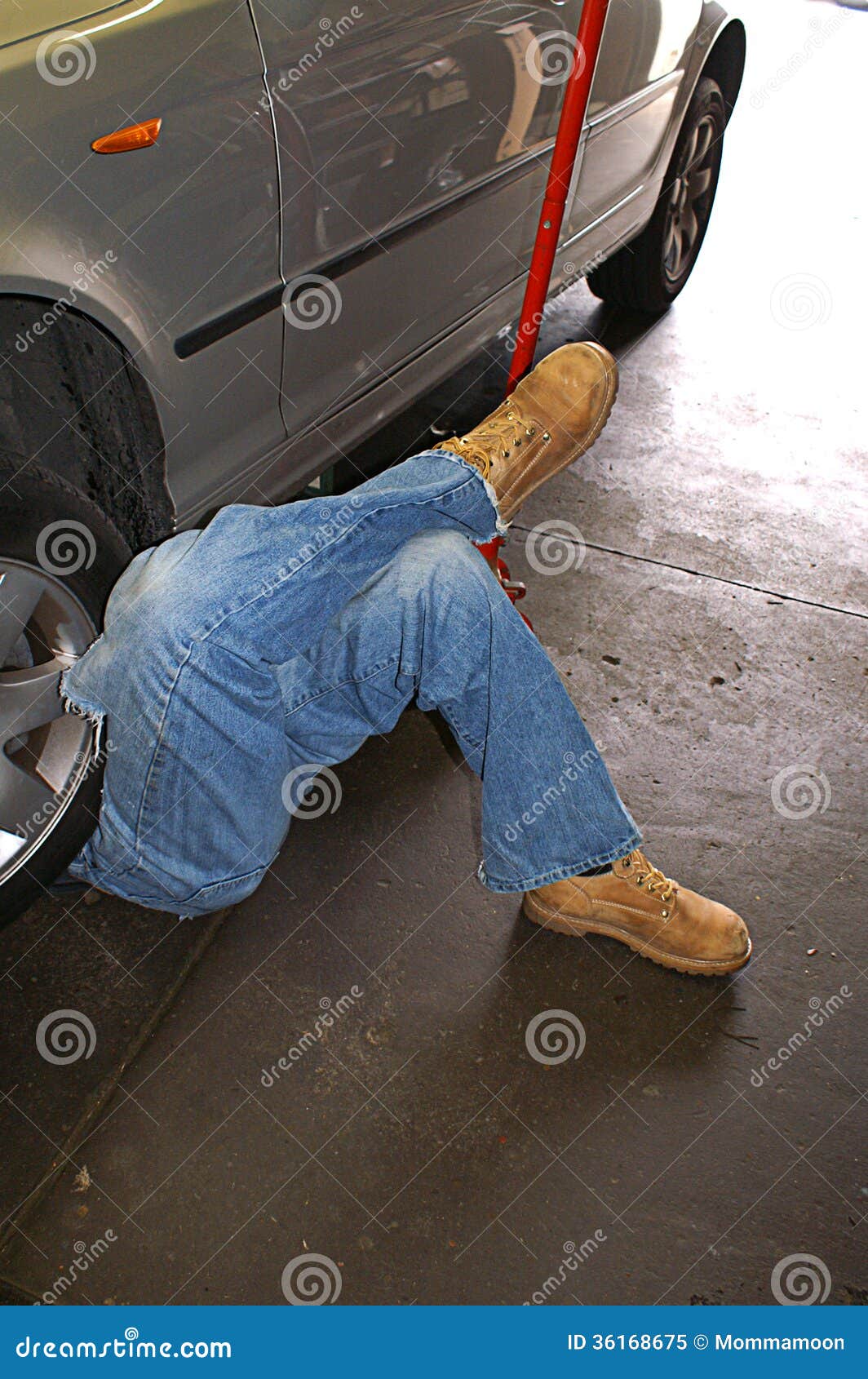Man with Legs Crossed Working Under a Car Stock Image - Image of legs ...