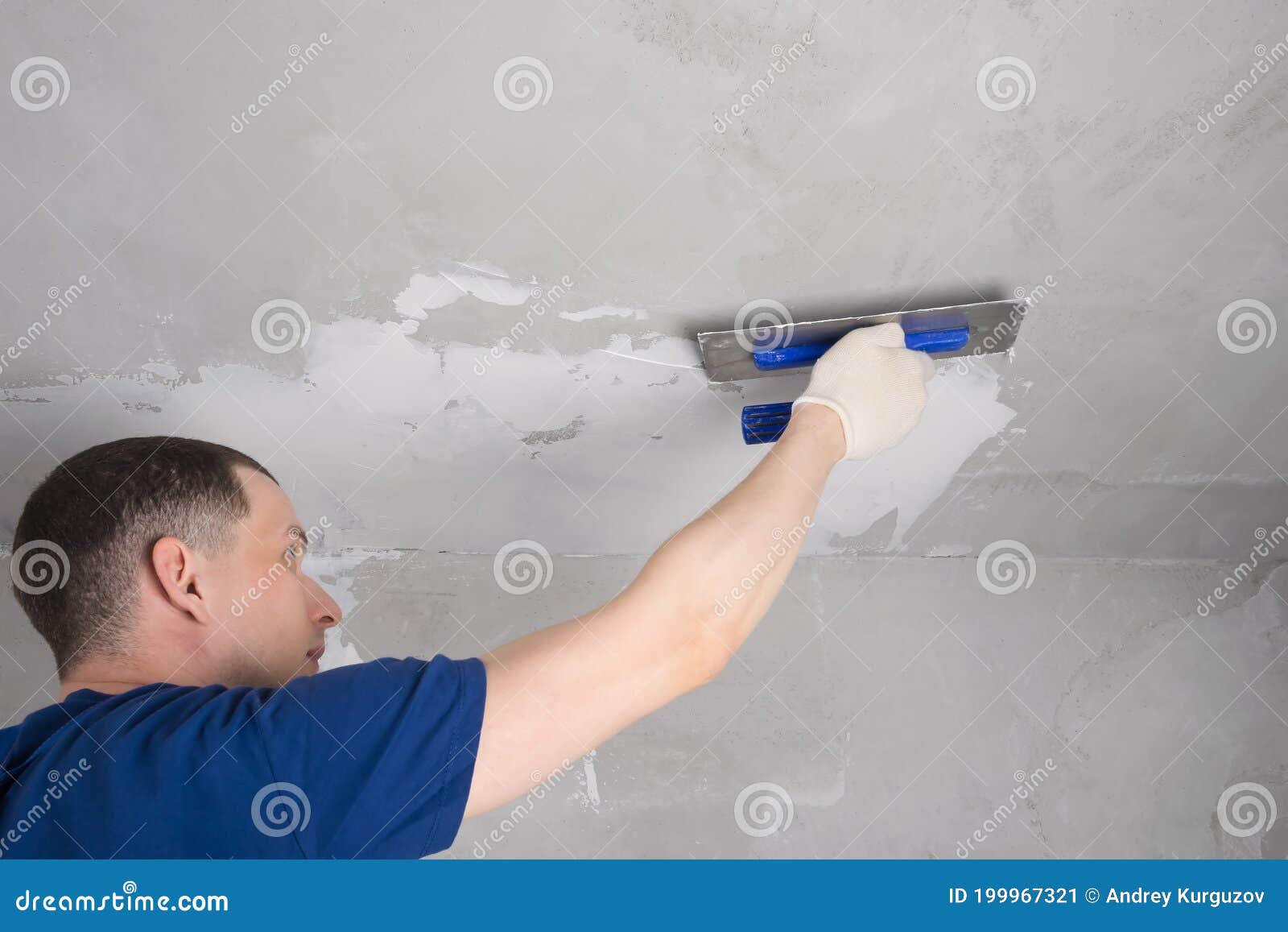 A Man Levels the Ceiling with a White Mortar Using a Spatula, Repair ...