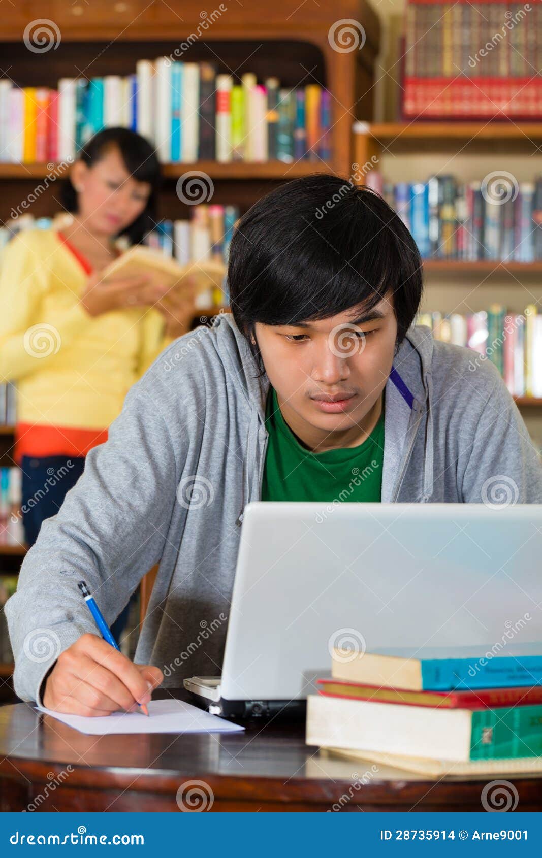 Man in library with laptop stock photo. Image of computer - 28735914