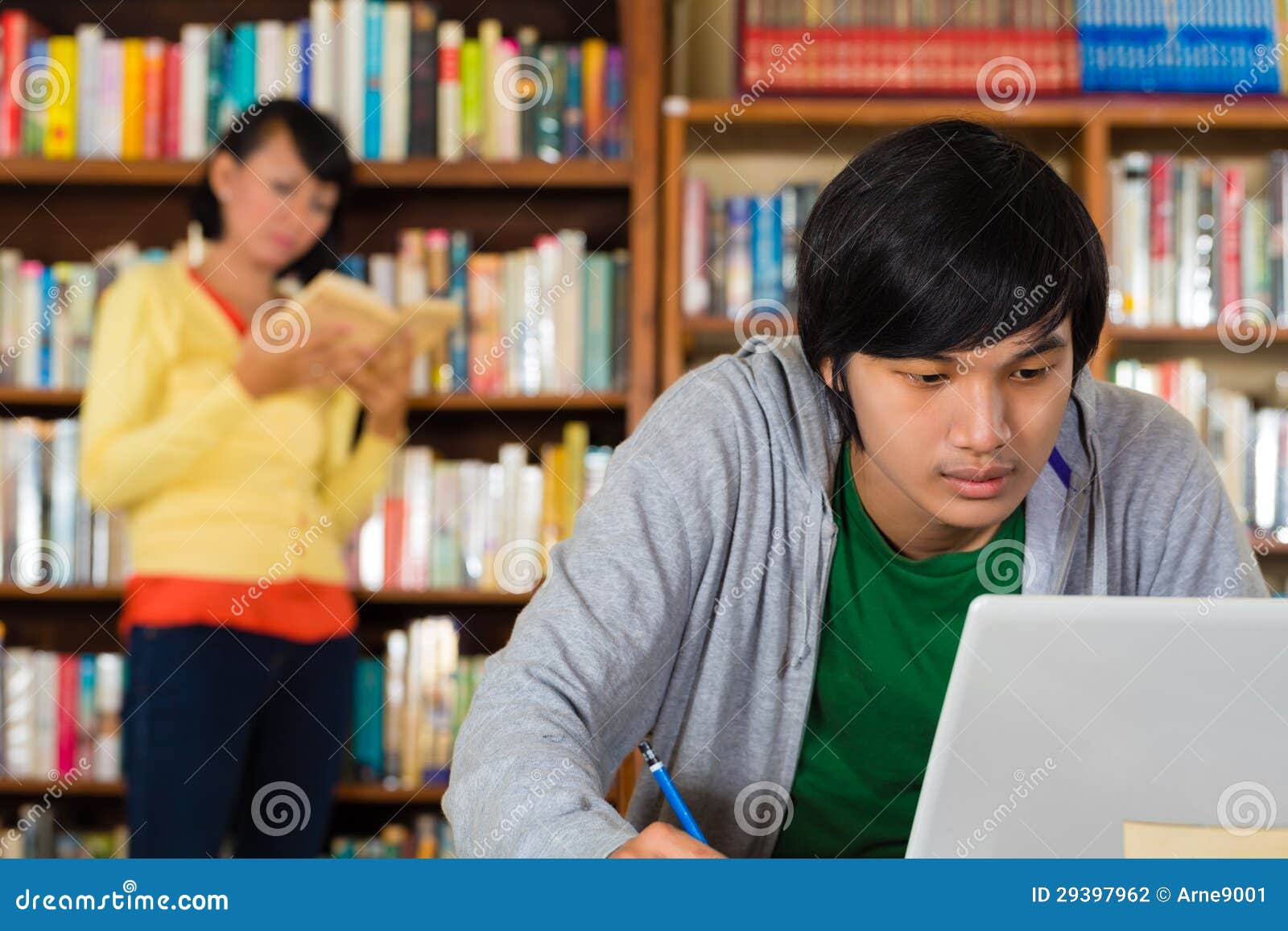 Man in library with laptop stock photo. Image of concentration - 29397962