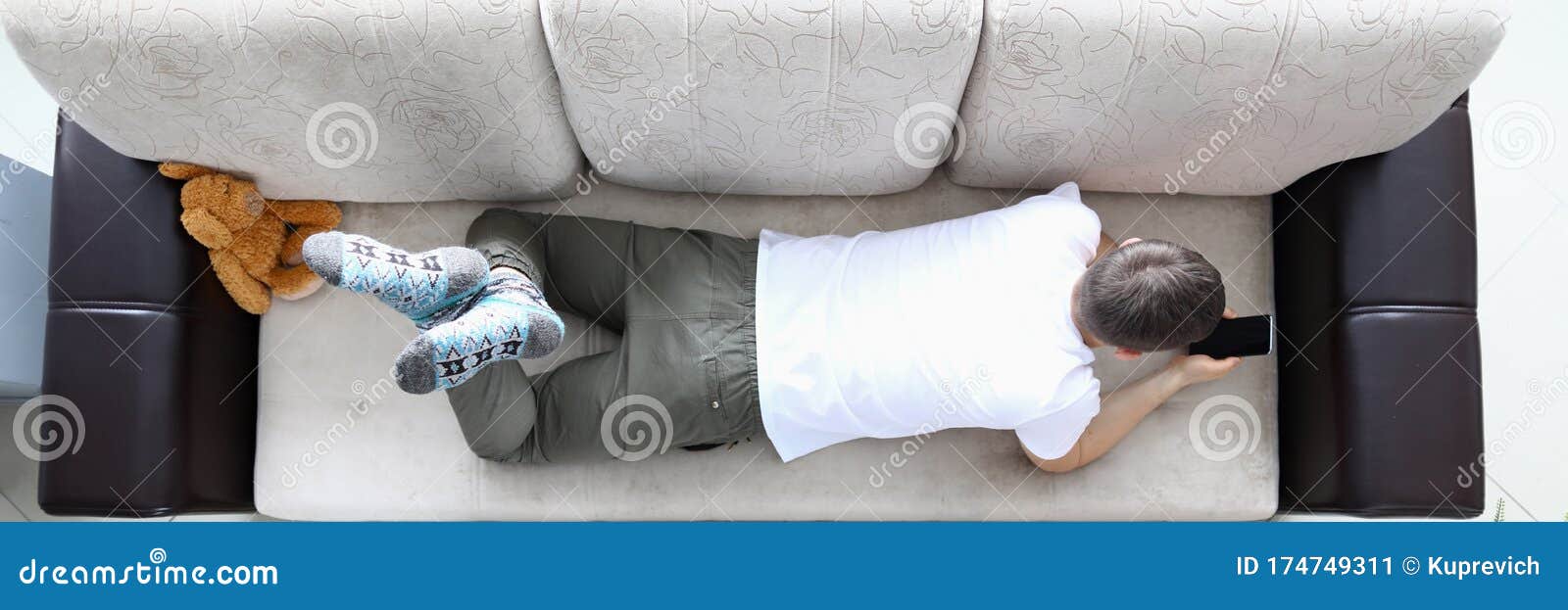 Man Lie on Sofa and Hold Modern Smartphone in Hand Stock Image - Image ...