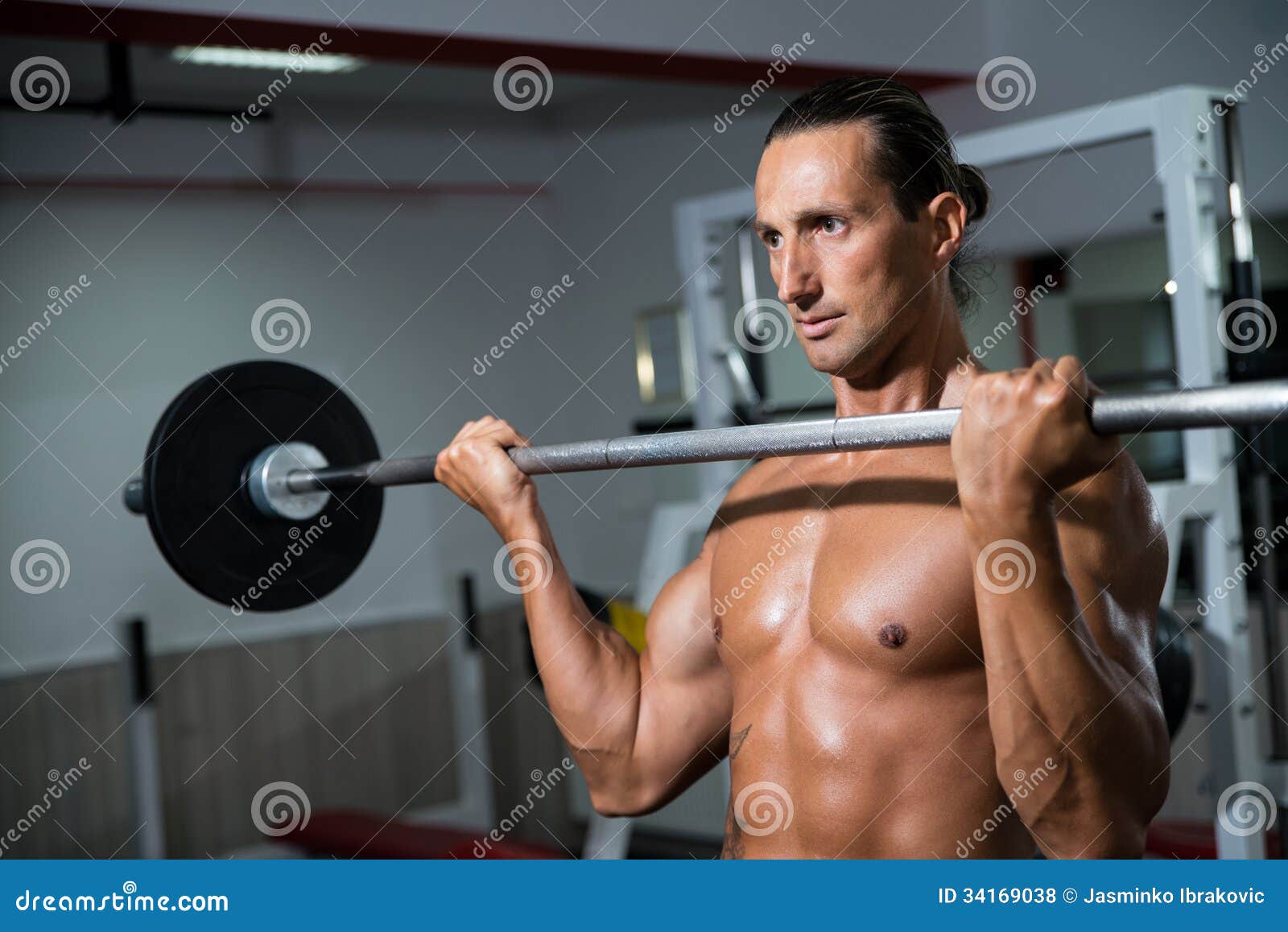 Man Lifting Barbell in Gym stock photo. Image of person - 34169038