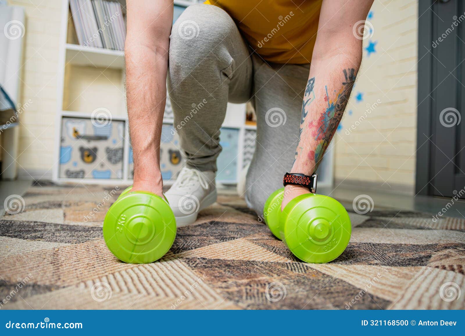 Man Lifting Green Dumbbells during Home Workout Stock Photo - Image of ...