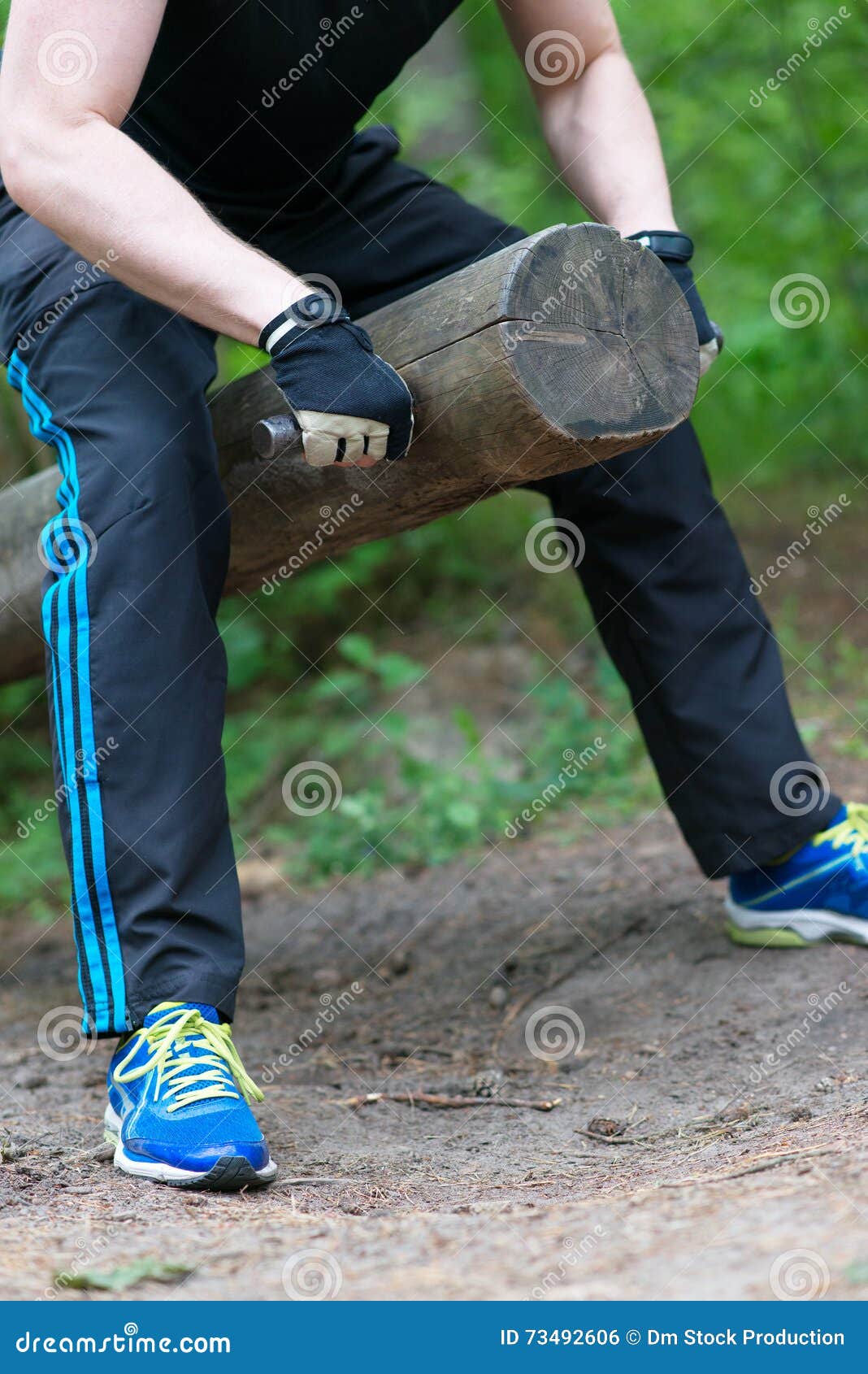 Man lifting log. stock photo. Image of masculine, bodybuilding - 73492606