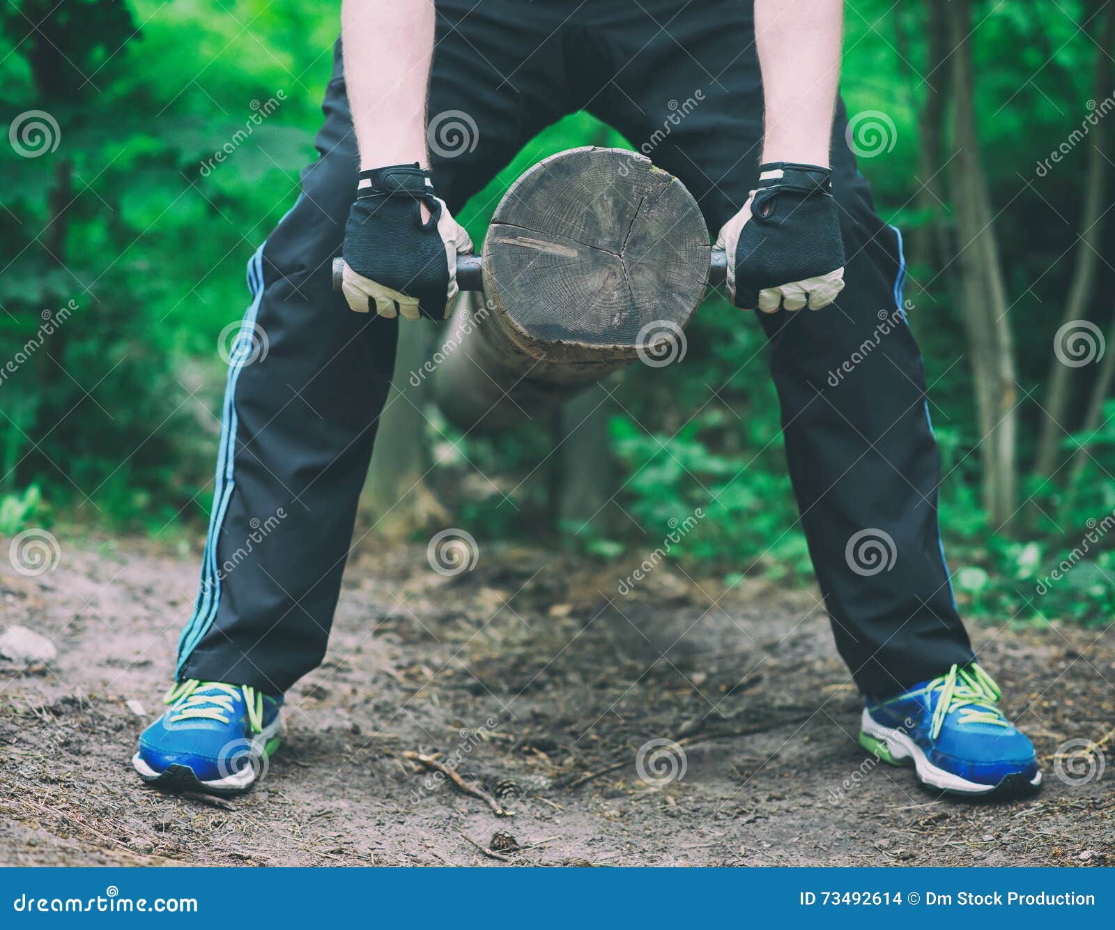 Man lifting log. stock photo. Image of muscles, healthy - 73492614