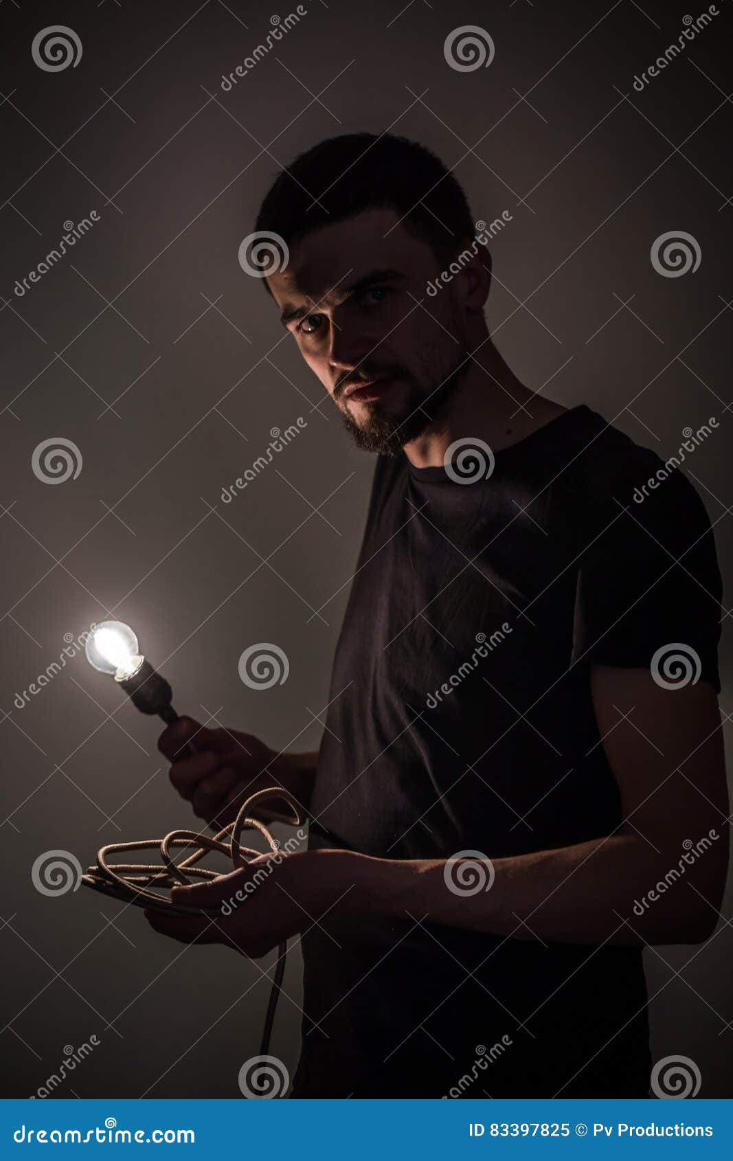 The Man with the Light Bulb on Black Background Stock Image - Image of ...