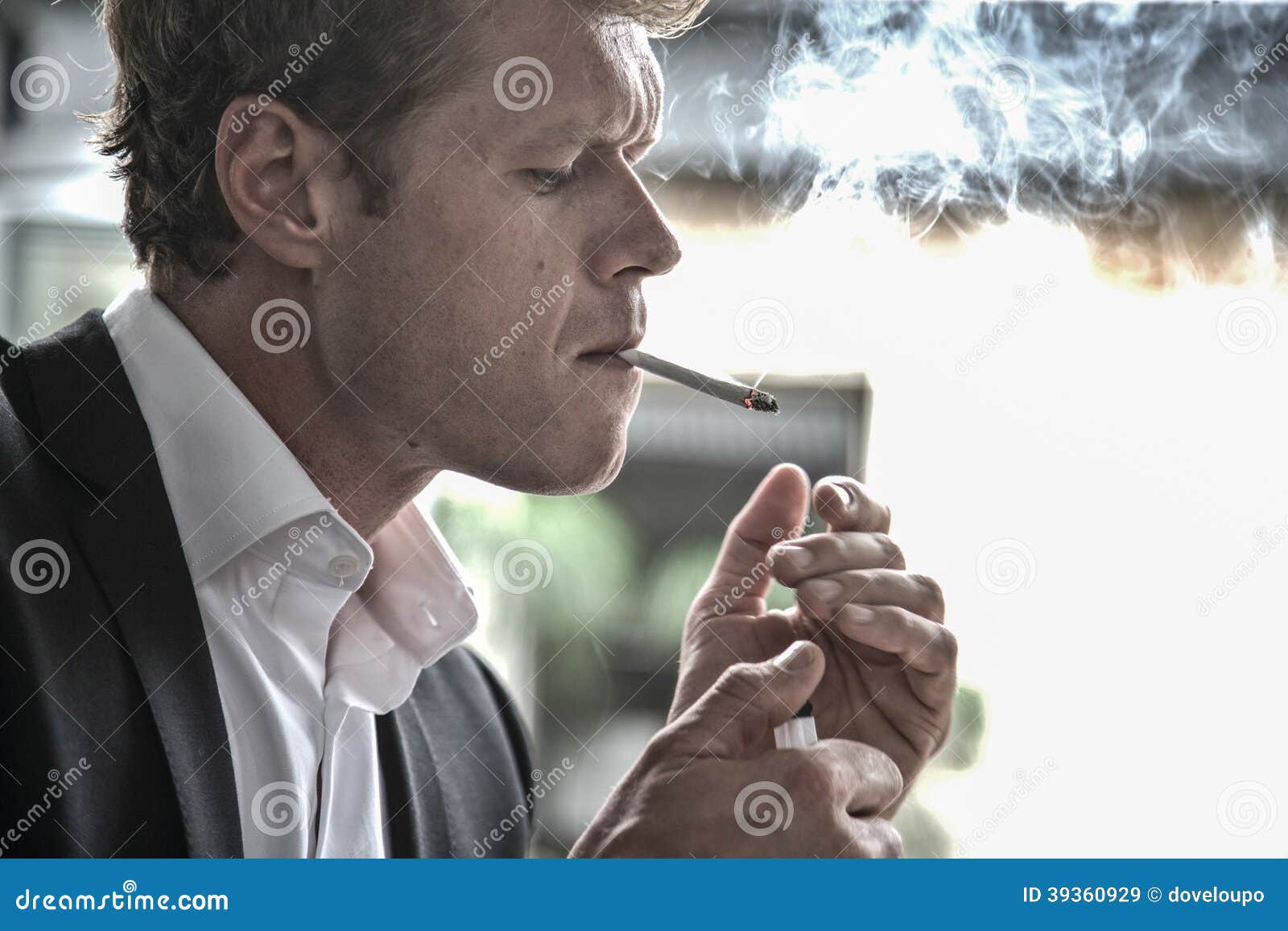 Man lighting cigarette stock image. Image of smoking - 39360929