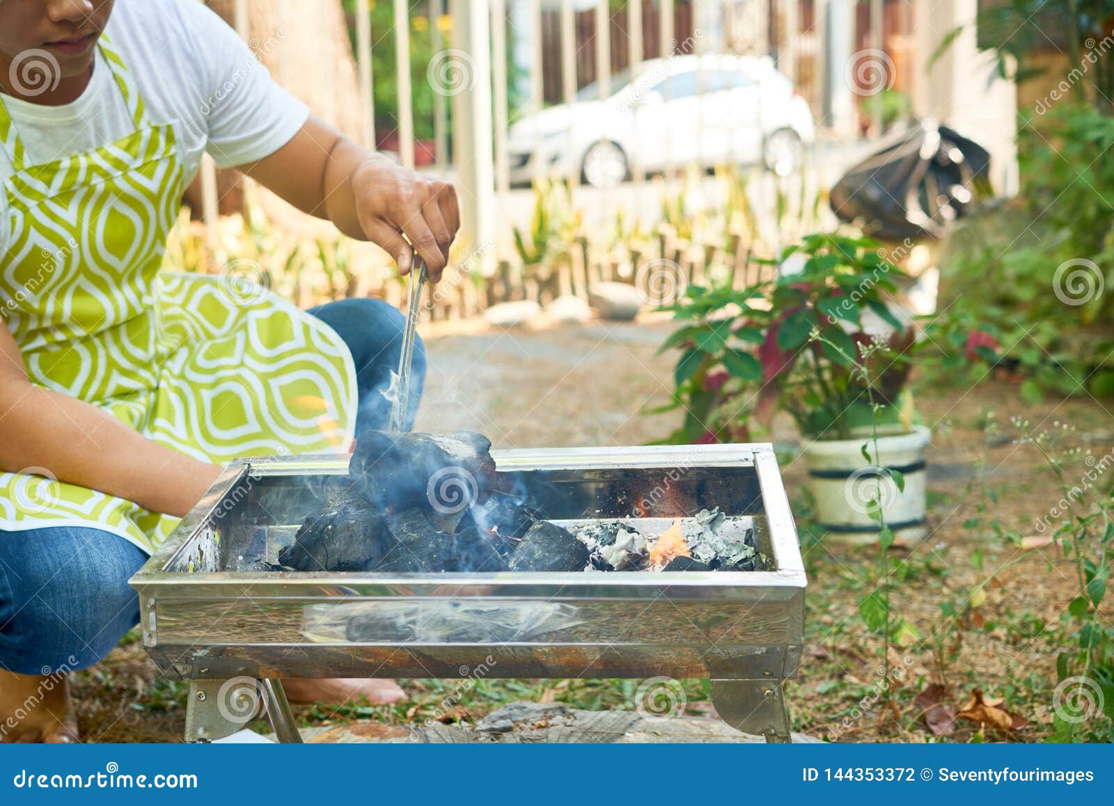 Man Lighting Fire for Barbecue Stock Photo - Image of garden, serious ...
