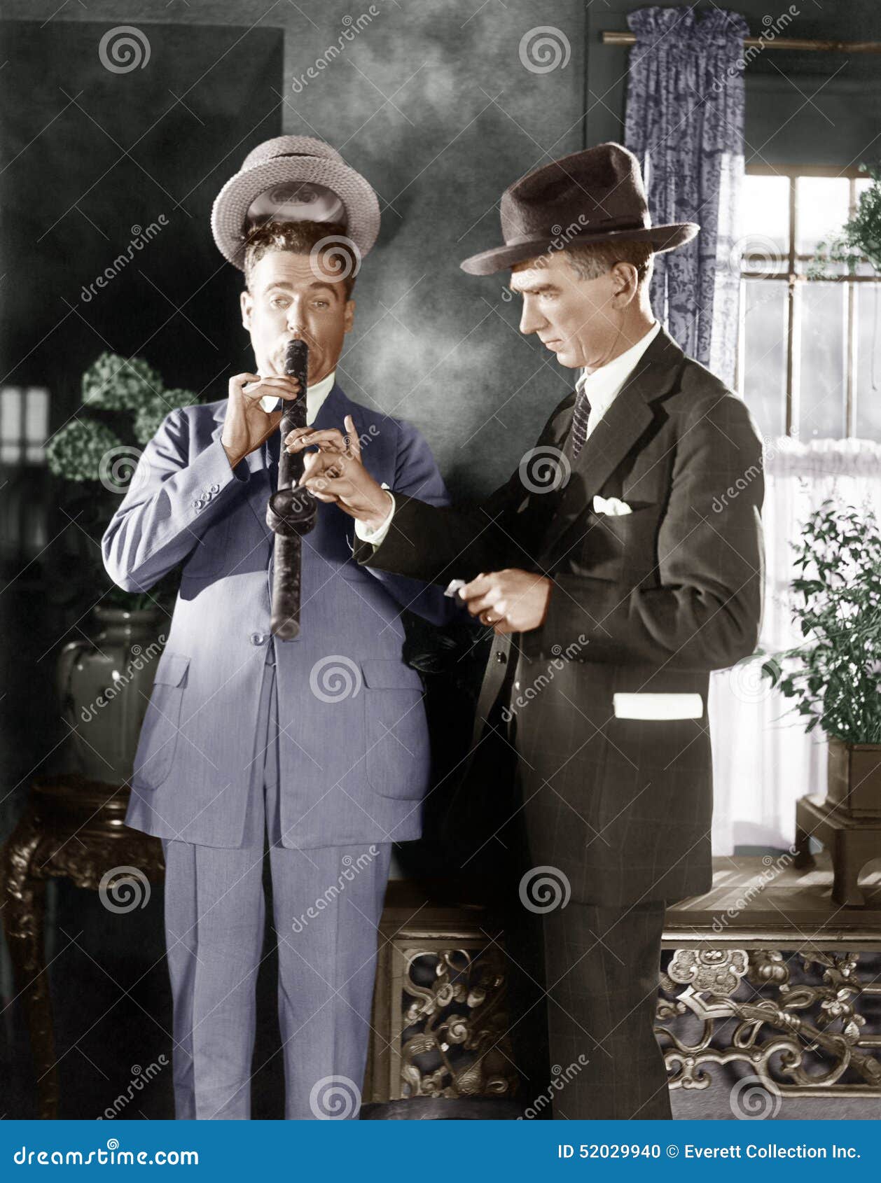 Man Lighting a Long Pipe while His Hat is Lifting Up from His Head ...