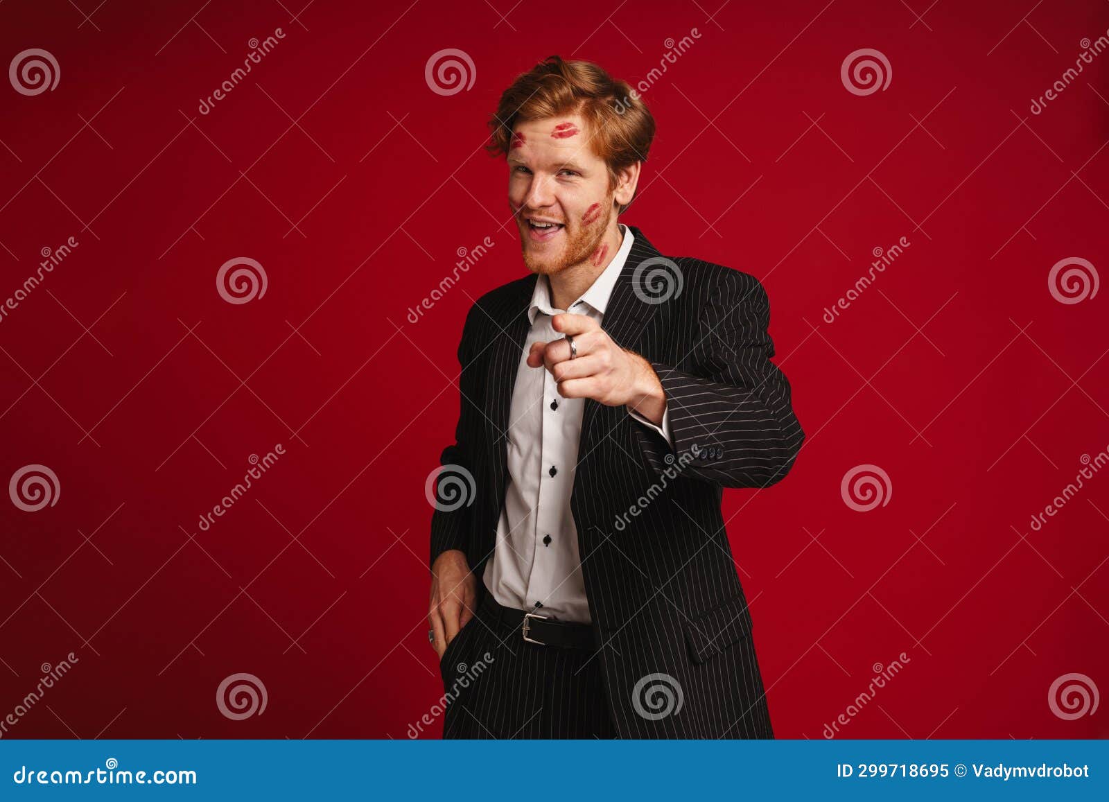 Man with Lipstick Marks on Face Pointing Finger at Camera Isolated Over ...