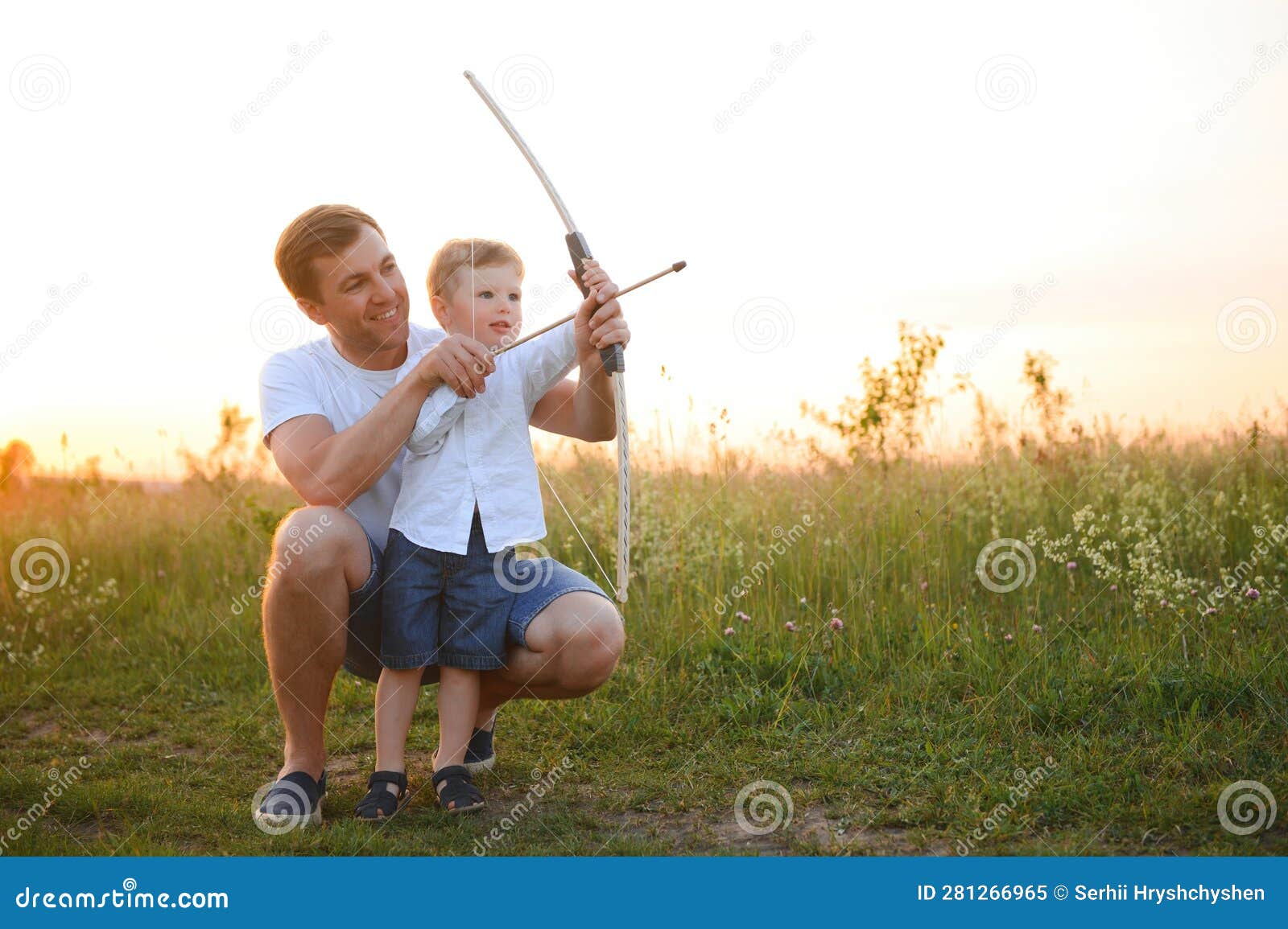 A Man and a Little Boy Doing Archery Stock Image - Image of preparing ...