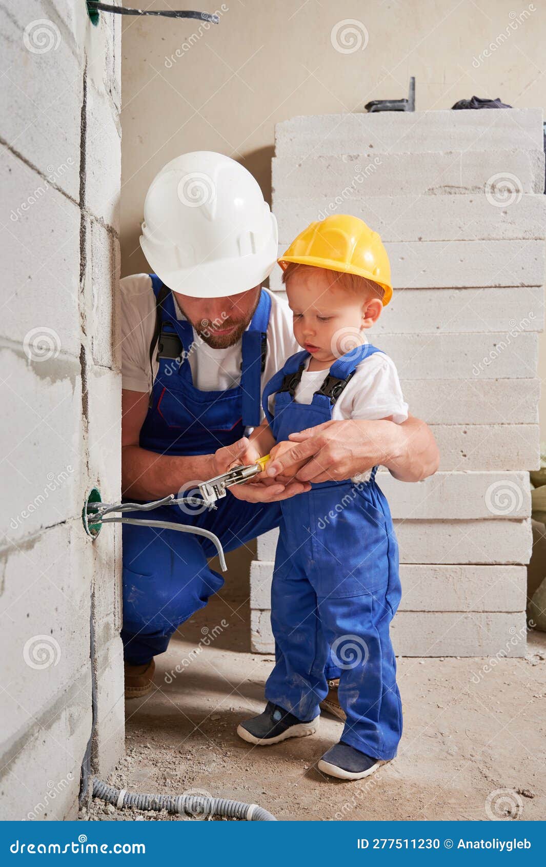 Man and Little Boy Installing Electric Cables and Socket at Home. Stock ...