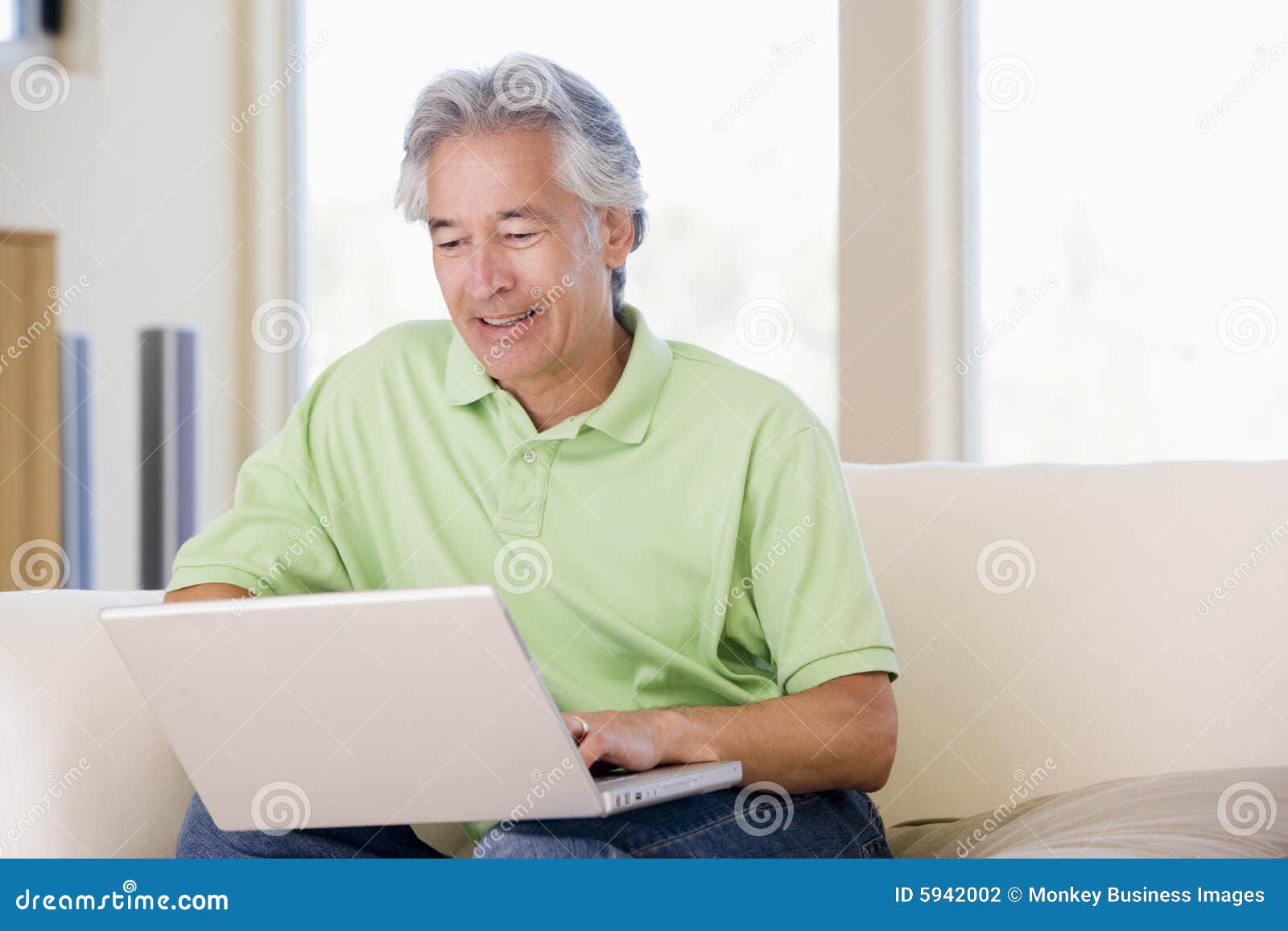 Man in Living Room with Laptop Smiling Stock Photo - Image of computer ...