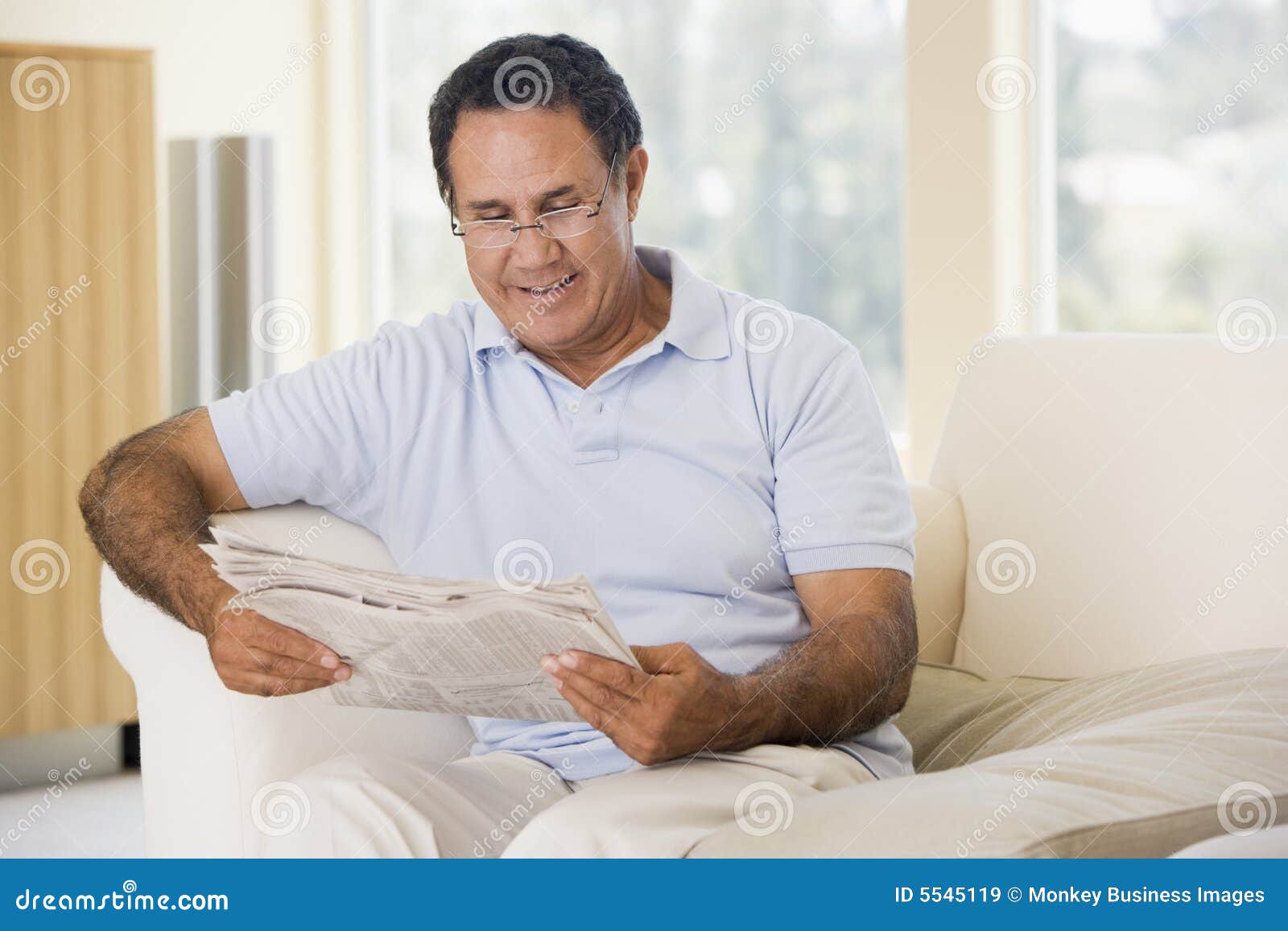 Man in Living Room Reading Newspaper Smiling Stock Image - Image of ...