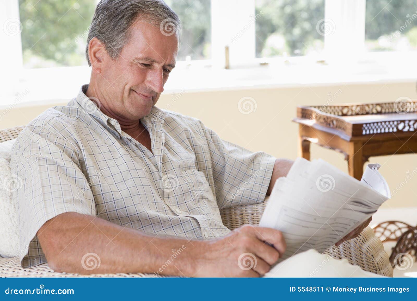 Man in Living Room Reading Newspaper Smiling Stock Image - Image of ...