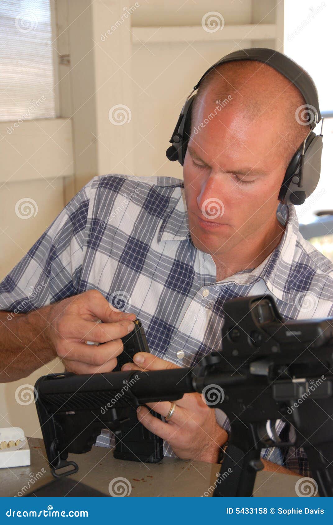 Man loading ammo. stock photo. Image of male, hobby, range - 5433158