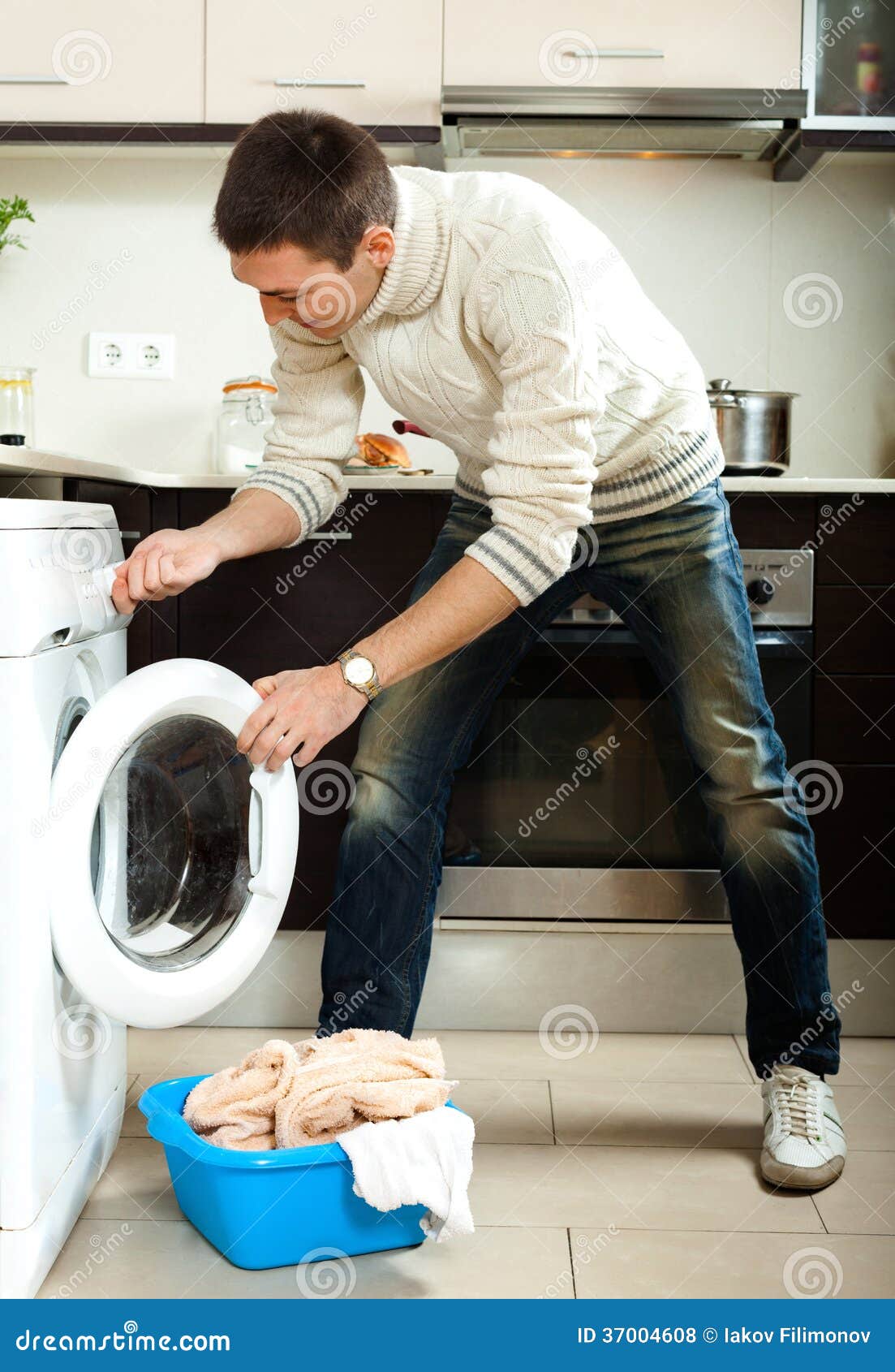 Man Loading Clothes into the Washing Machine Stock Photo - Image of ...