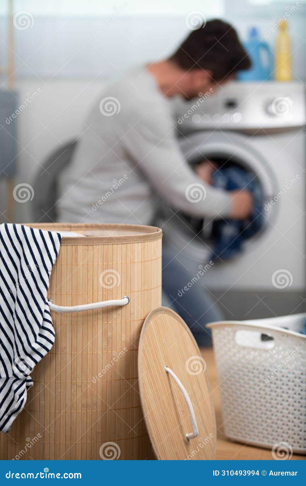 Man Loading Clothes into Washing Machine in Kitchen Stock Photo - Image ...
