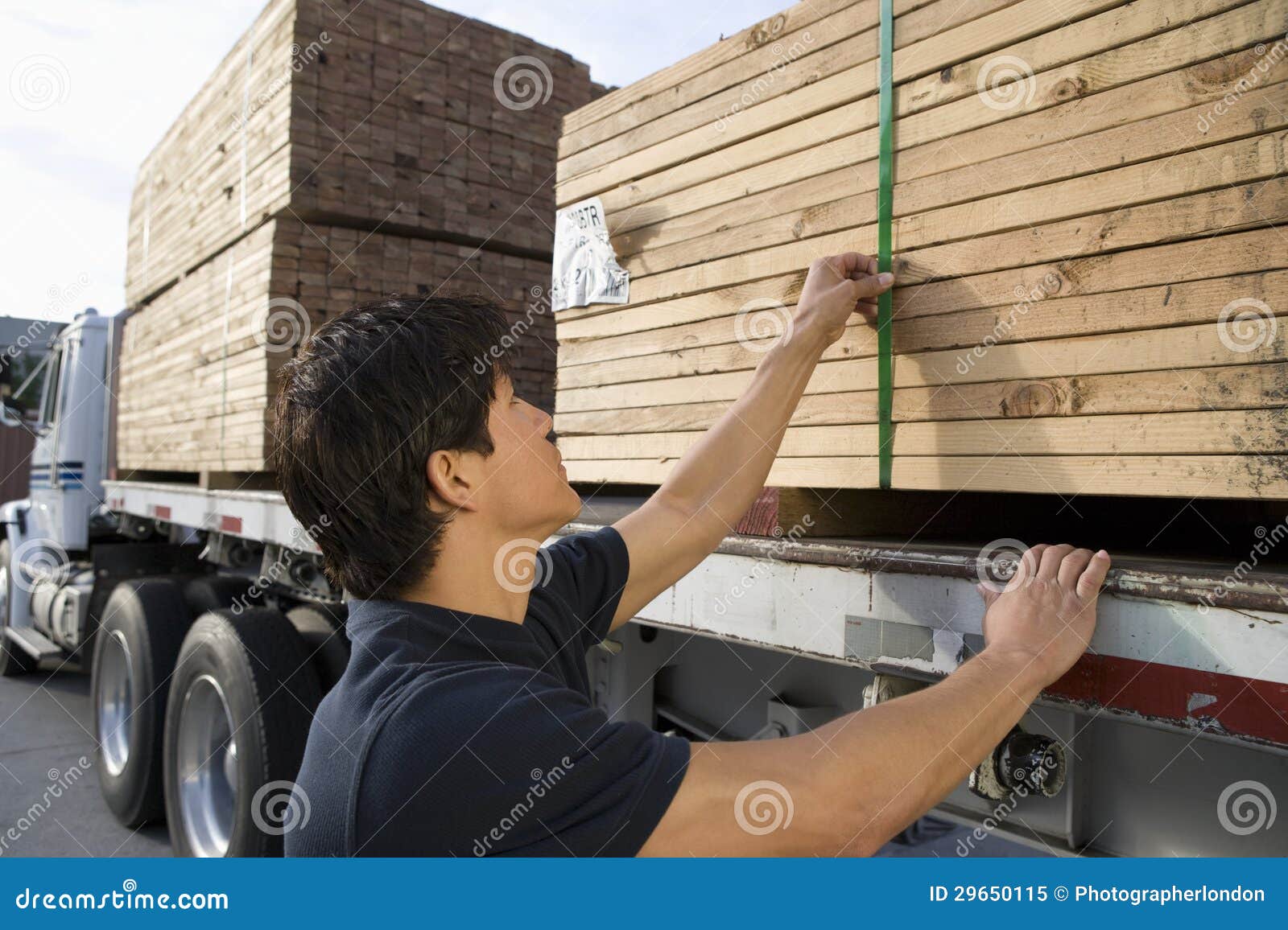 Man Loading Stack of Plank on Trailer Stock Image - Image of loading ...