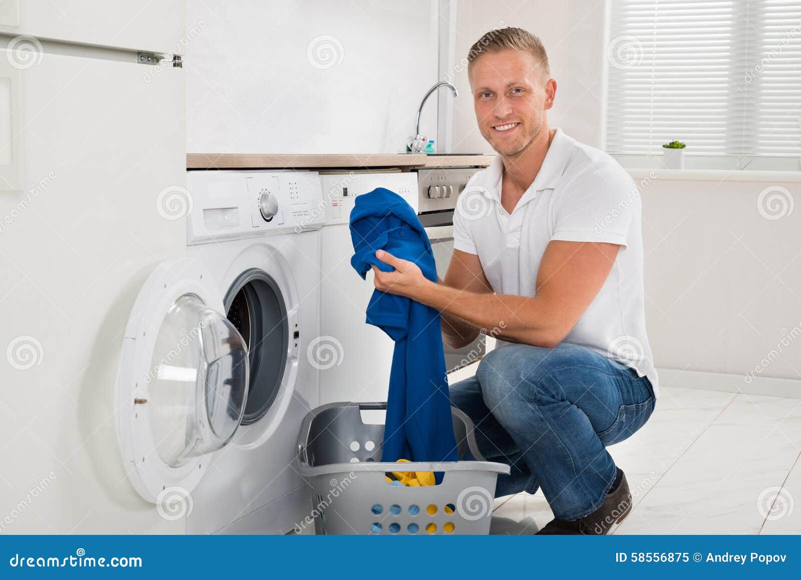 Man Loading Washing Machine with Clothes Stock Image - Image of ...