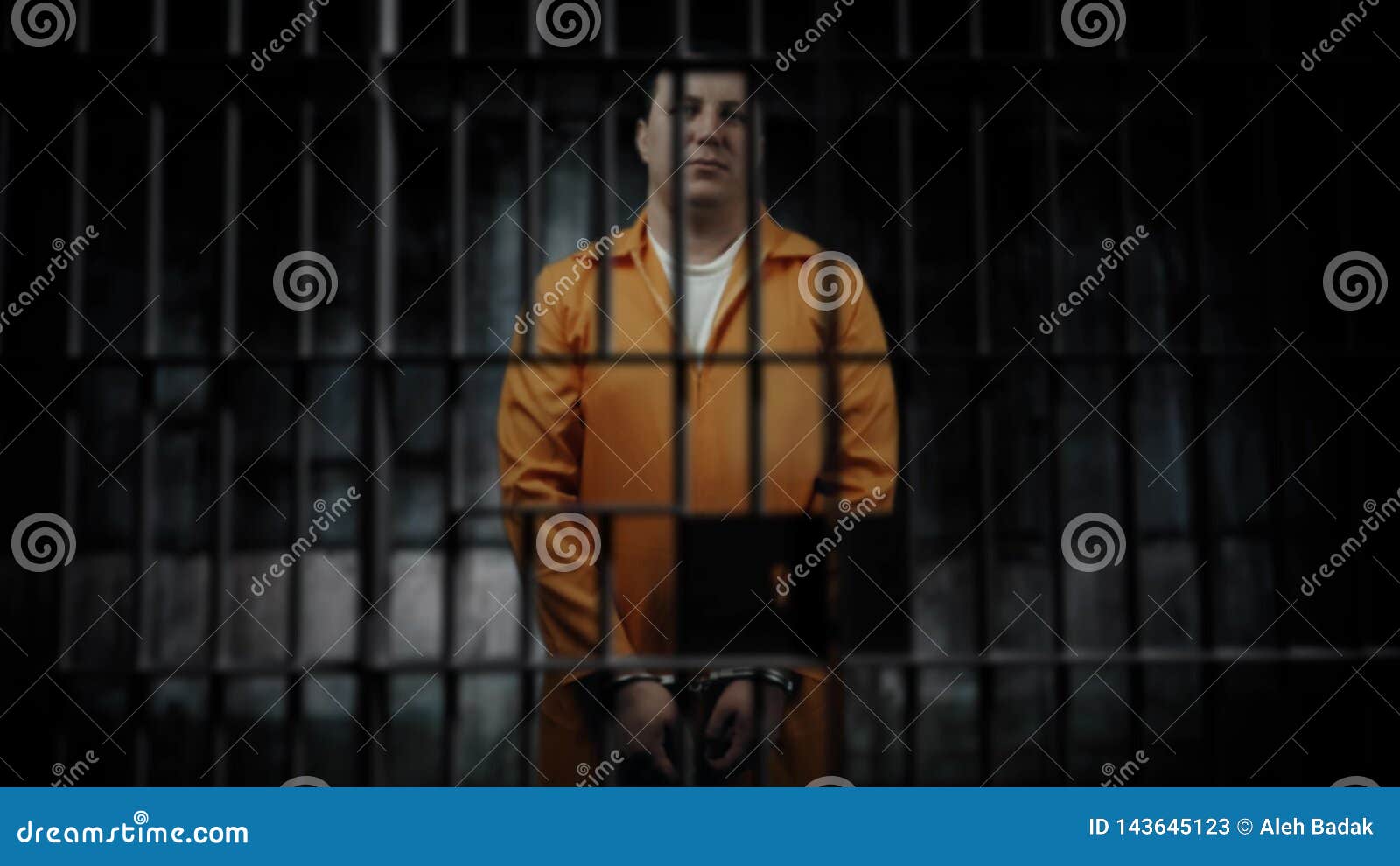 A Man is Locked in a Prison Cell. Prisoner with Handcuff is Looking at ...