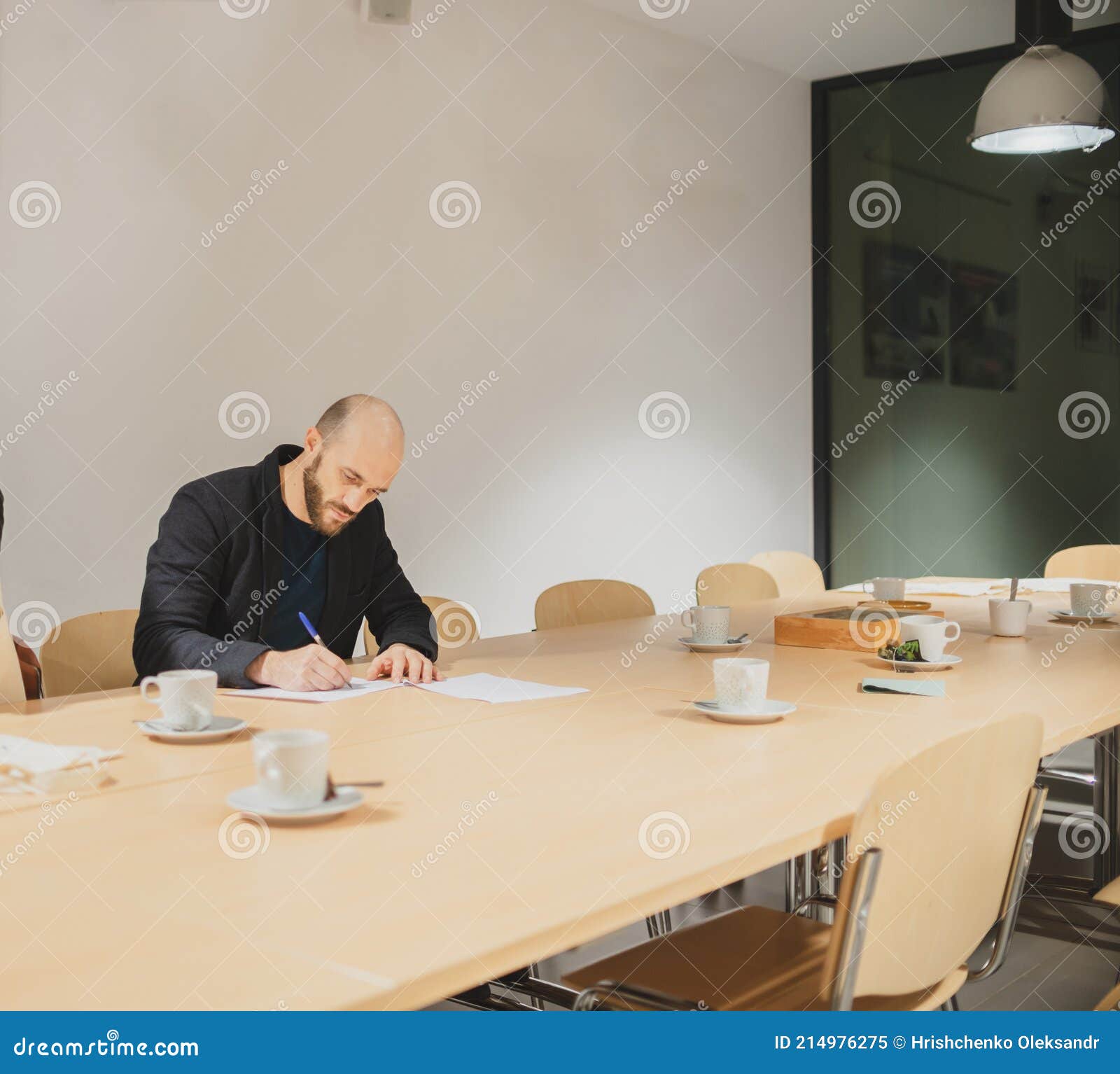 A Man at a Long Table Signs a Document Stock Image - Image of ...
