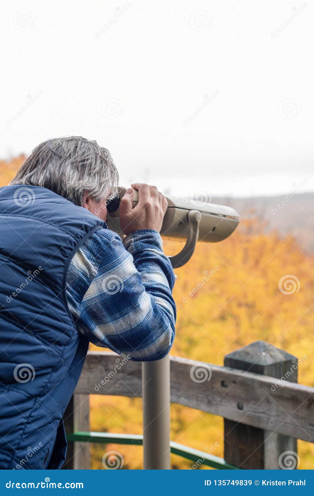 Man Looking through Binoculars at Scenic Overlook Vertical Stock Image ...