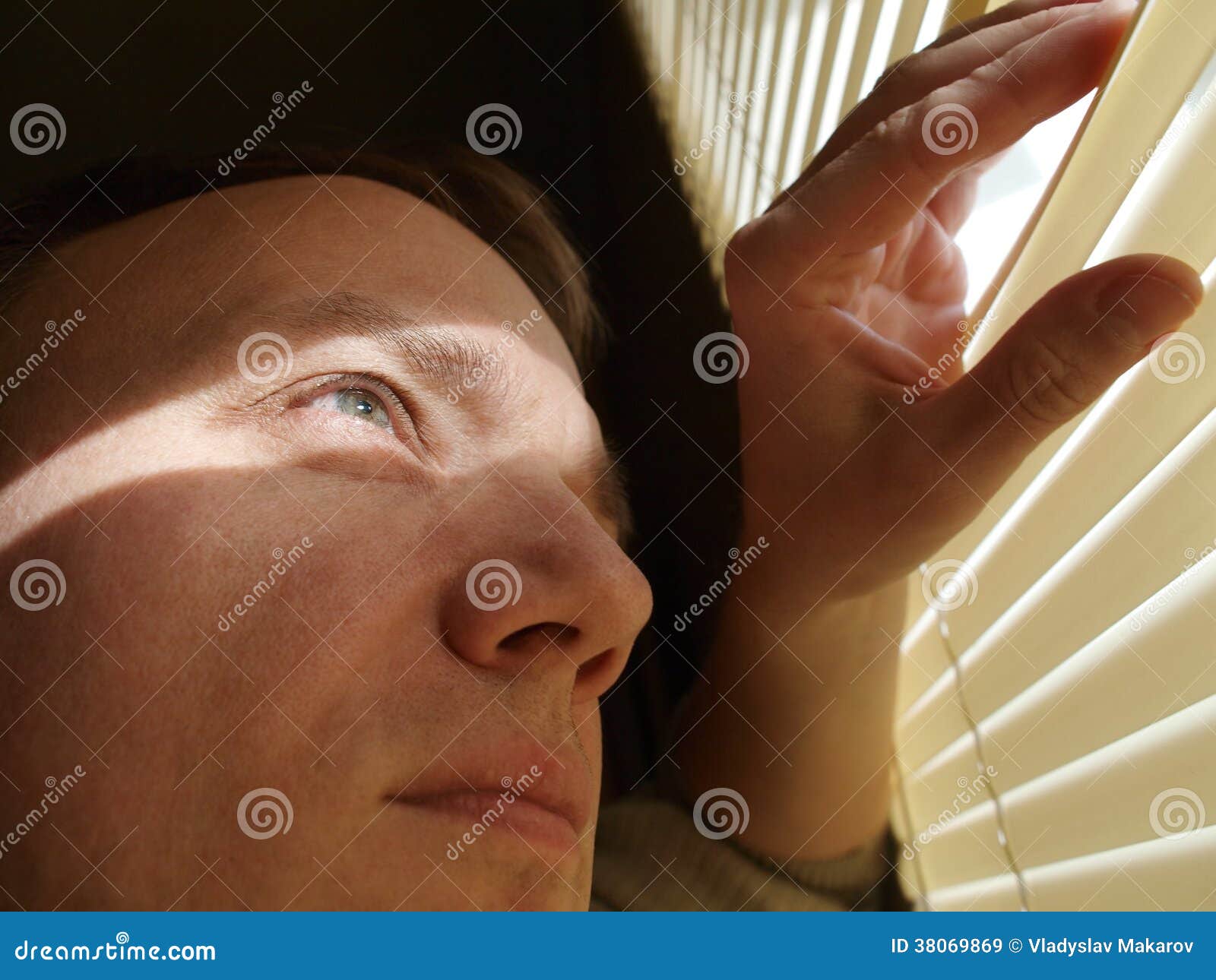 Man looking through blinds stock image. Image of investigator - 38069869