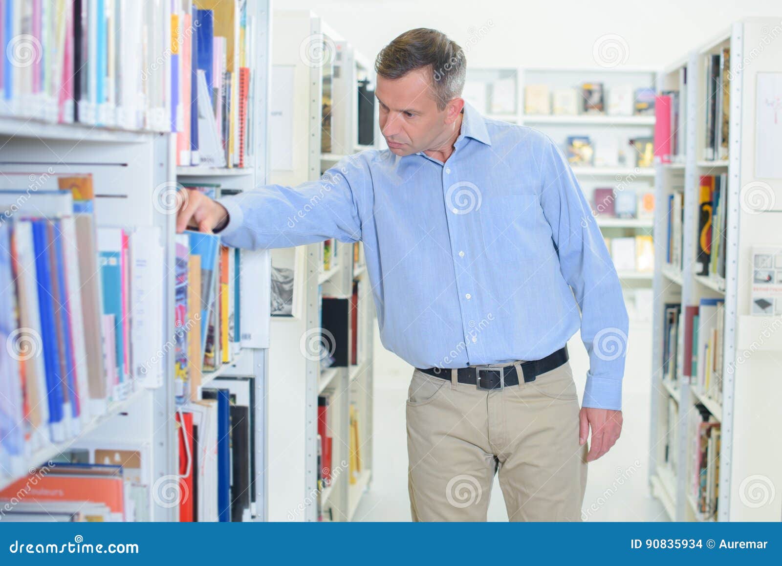Man looking for book stock photo. Image of place, grenre - 90835934