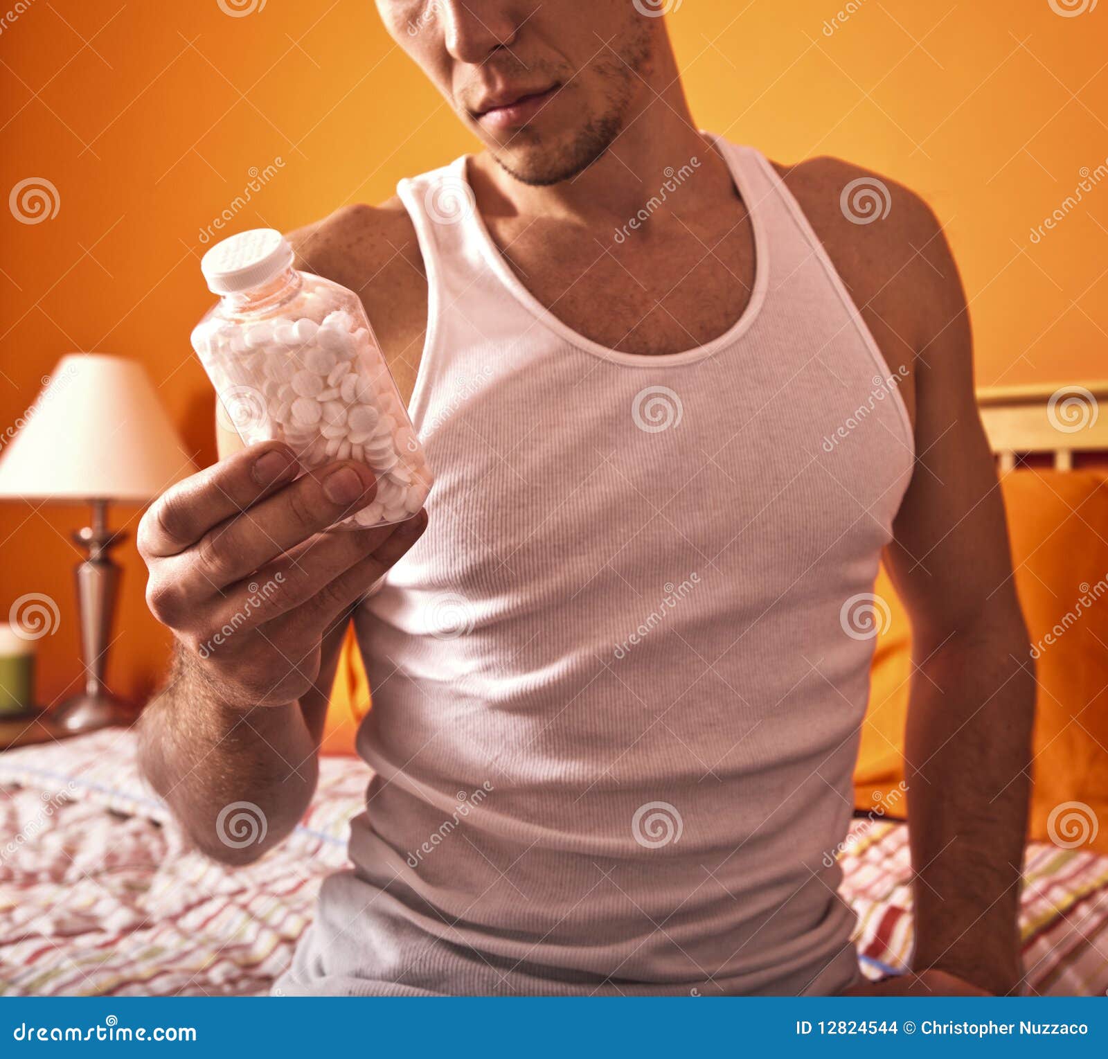Man Looking at Bottle of Pills Stock Photo - Image of indoors, medicine ...