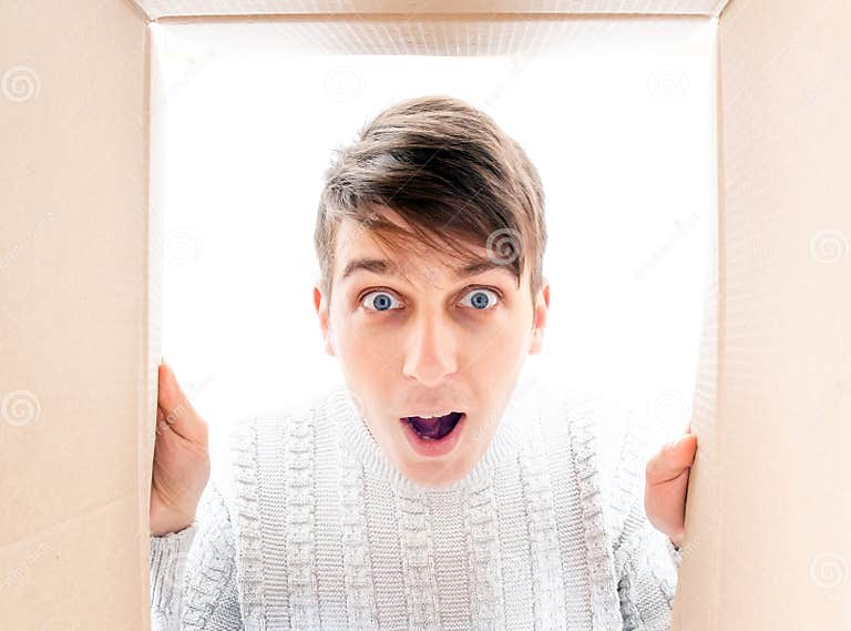 Man looking into a box stock image. Image of open, surprised - 298631345