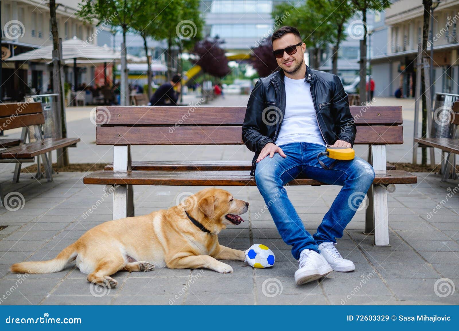 Man Looking at the Camera with His Dog Lying beside Him Stock Image ...