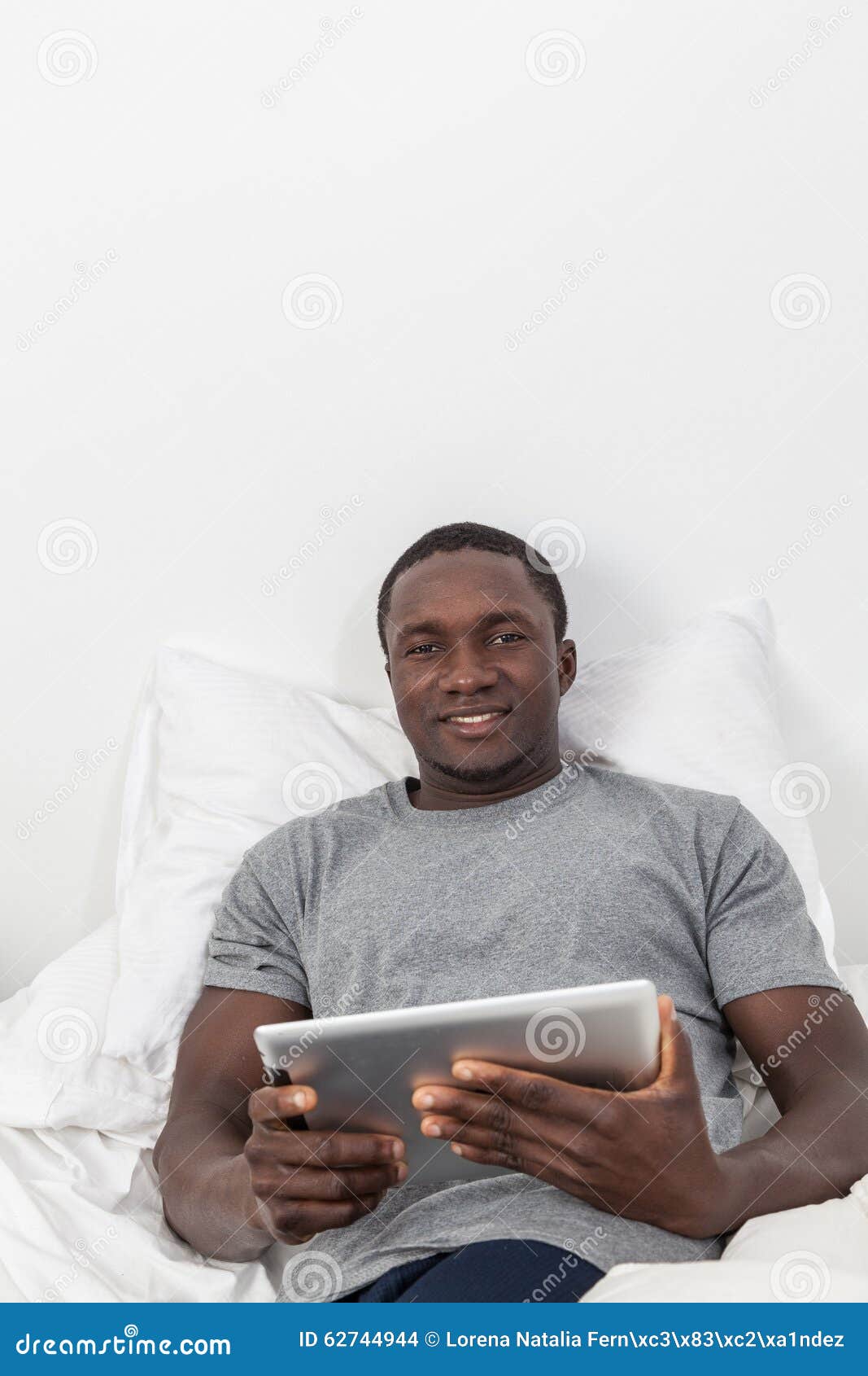 Man Looking at Camera and Holding His Tablet Stock Photo - Image of ...