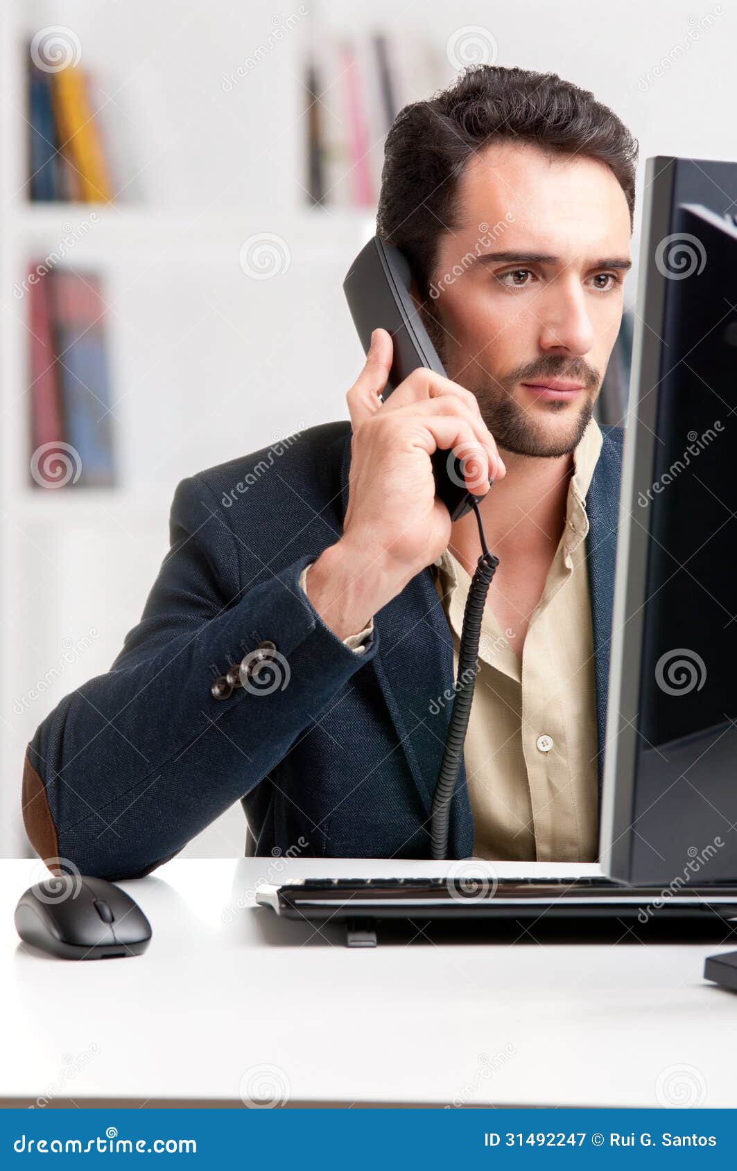 Man Looking at a Computer Monitor, on the Phone Stock Image - Image of ...