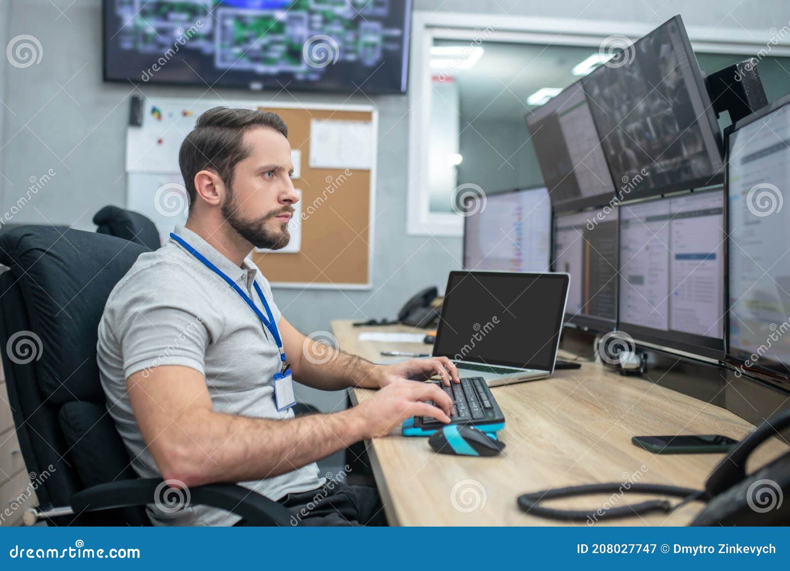 Man Looking at Computer Screens Sitting at Keyboard Stock Image - Image ...