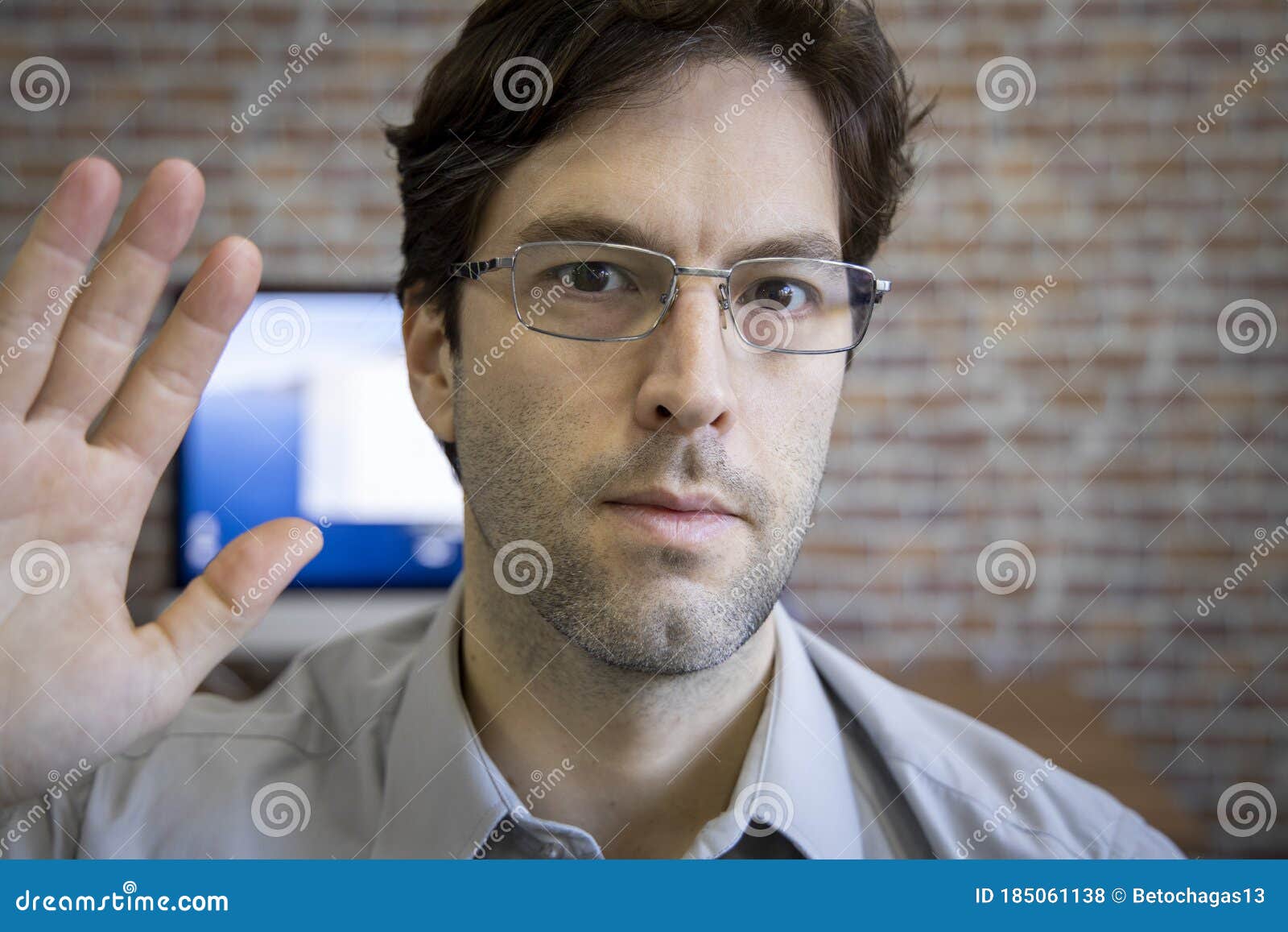 Man Looking Directly at the Camera Making a Conference Call Stock Photo ...