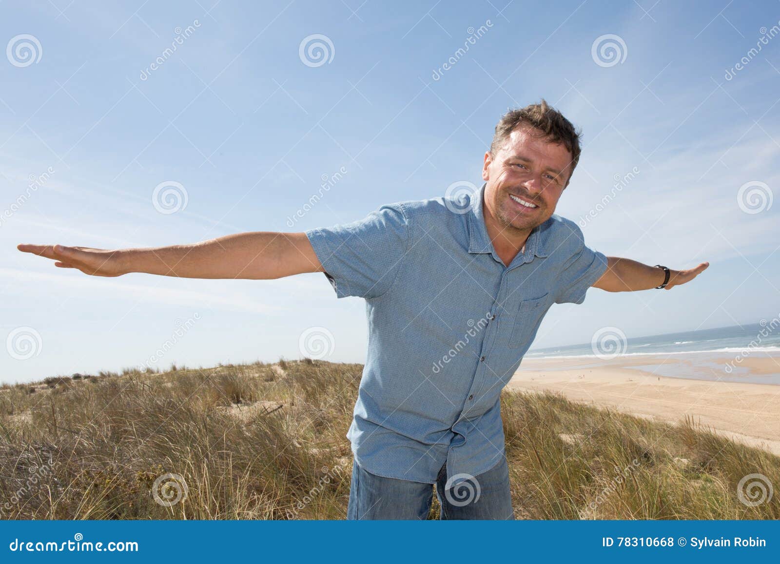 Man Looking into Distance with Hands Up Against the Sea Stock Photo ...