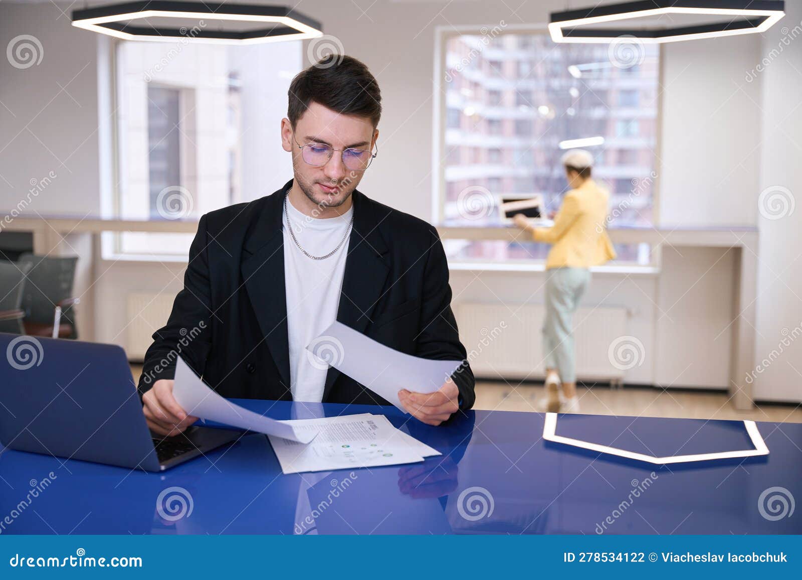 Man Looking through Documents at Coworking Space Stock Photo - Image of ...