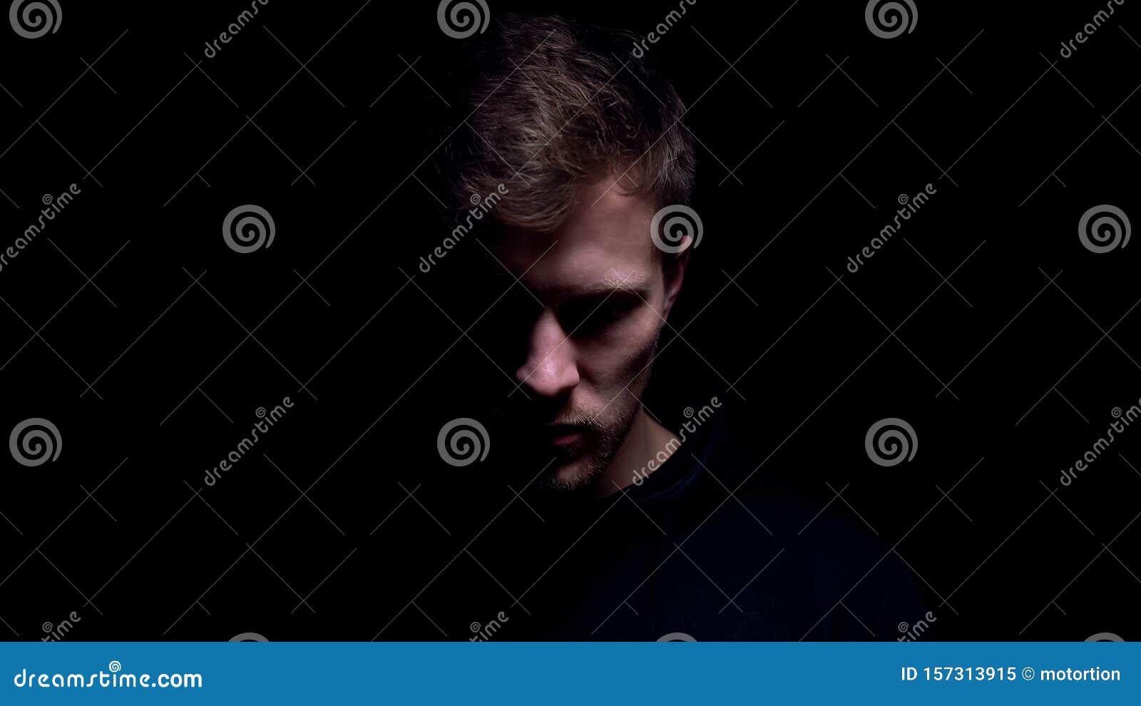 Man Looking Down Against Black Background, Feeling Guilty for Committed ...