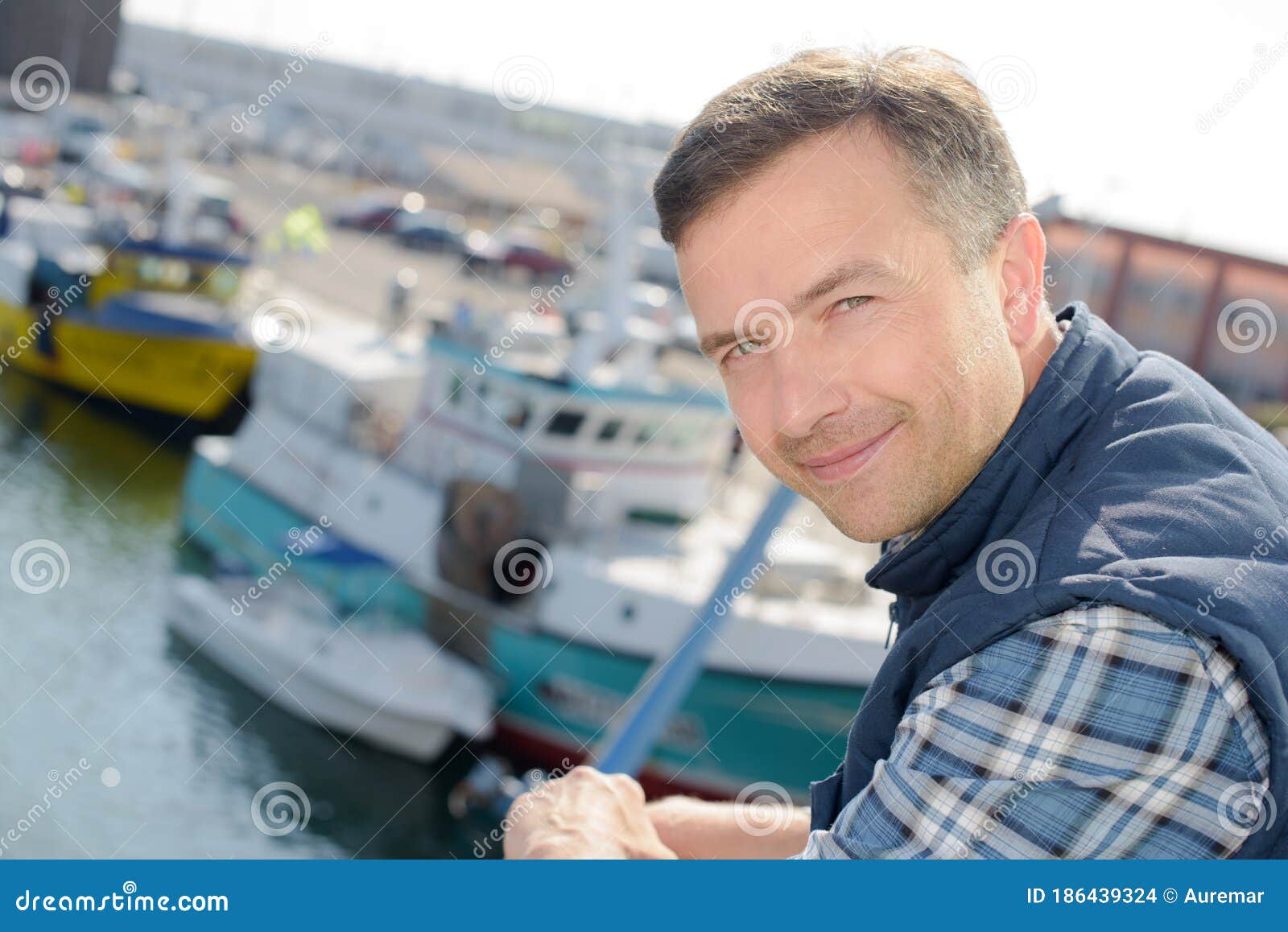 Man looking down at port stock photo. Image of pleasure - 186439324