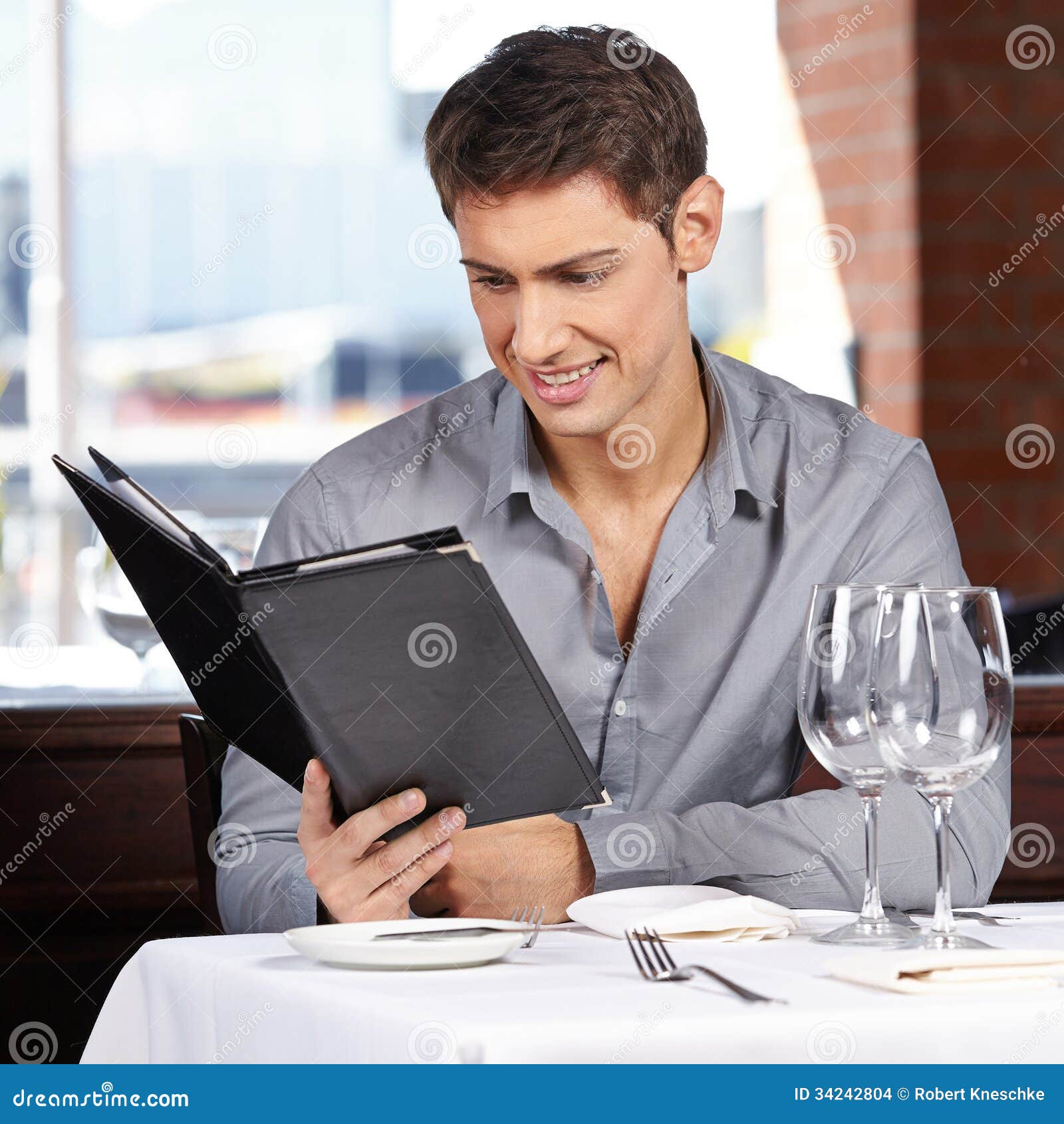 Man looking at drinks menu stock photo. Image of list - 34242804